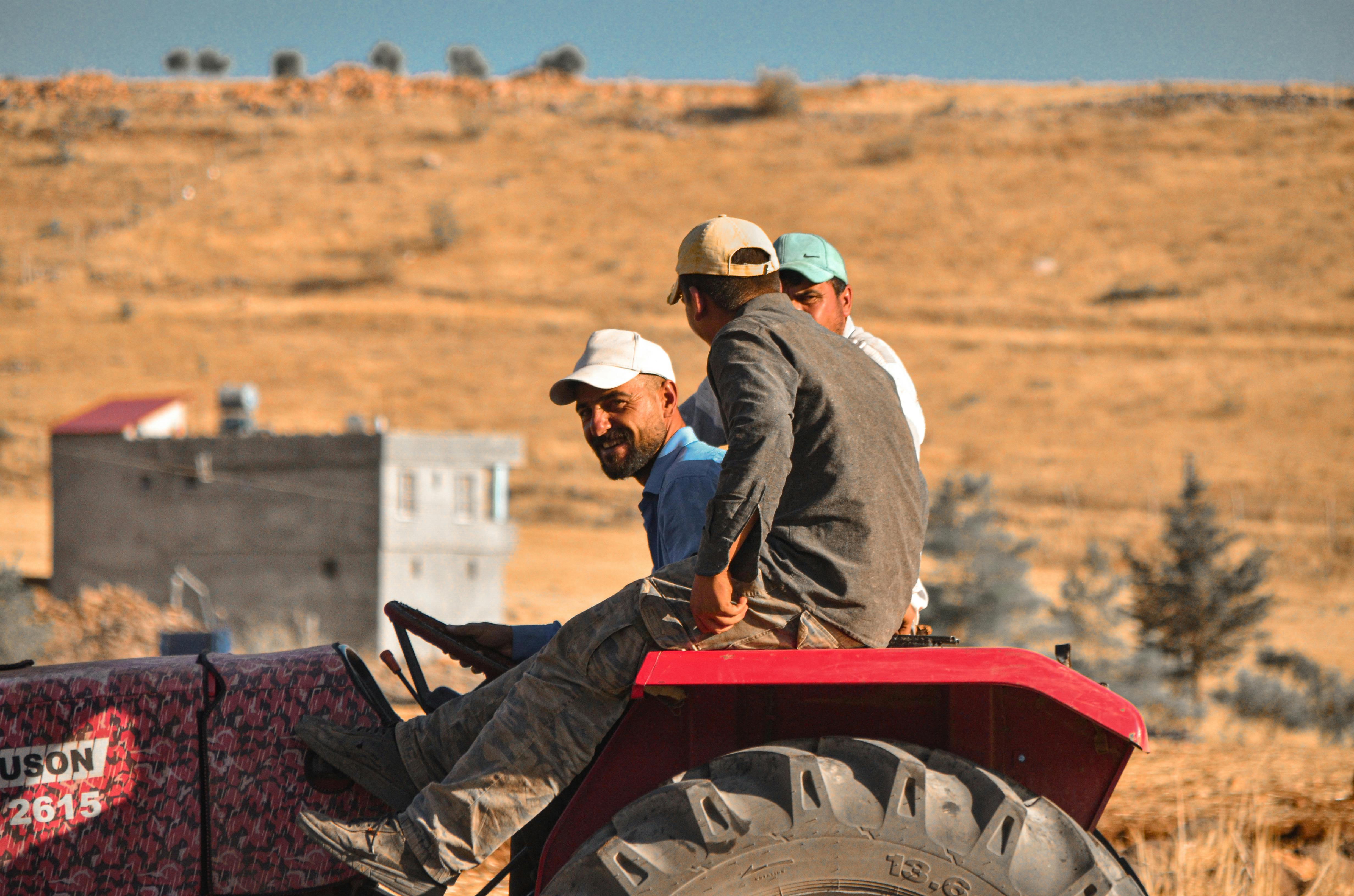 Farmers Riding Tractor in Rural Turkey · Free Stock Photo