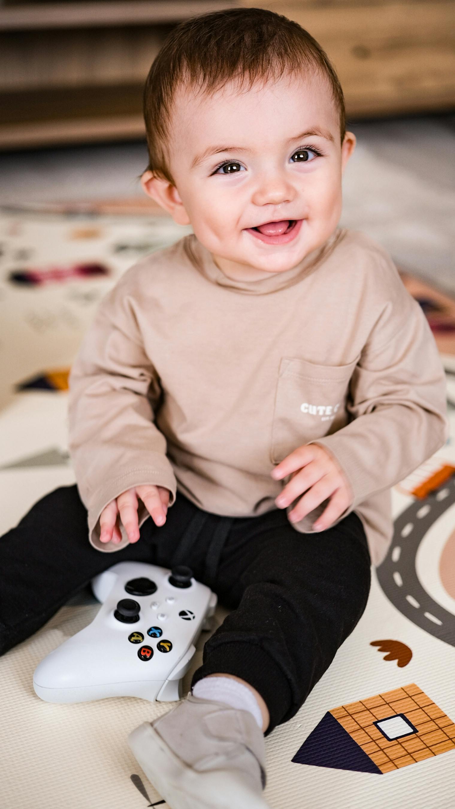 Adorable Baby Playing with Game Controller at Home · Free Stock Photo