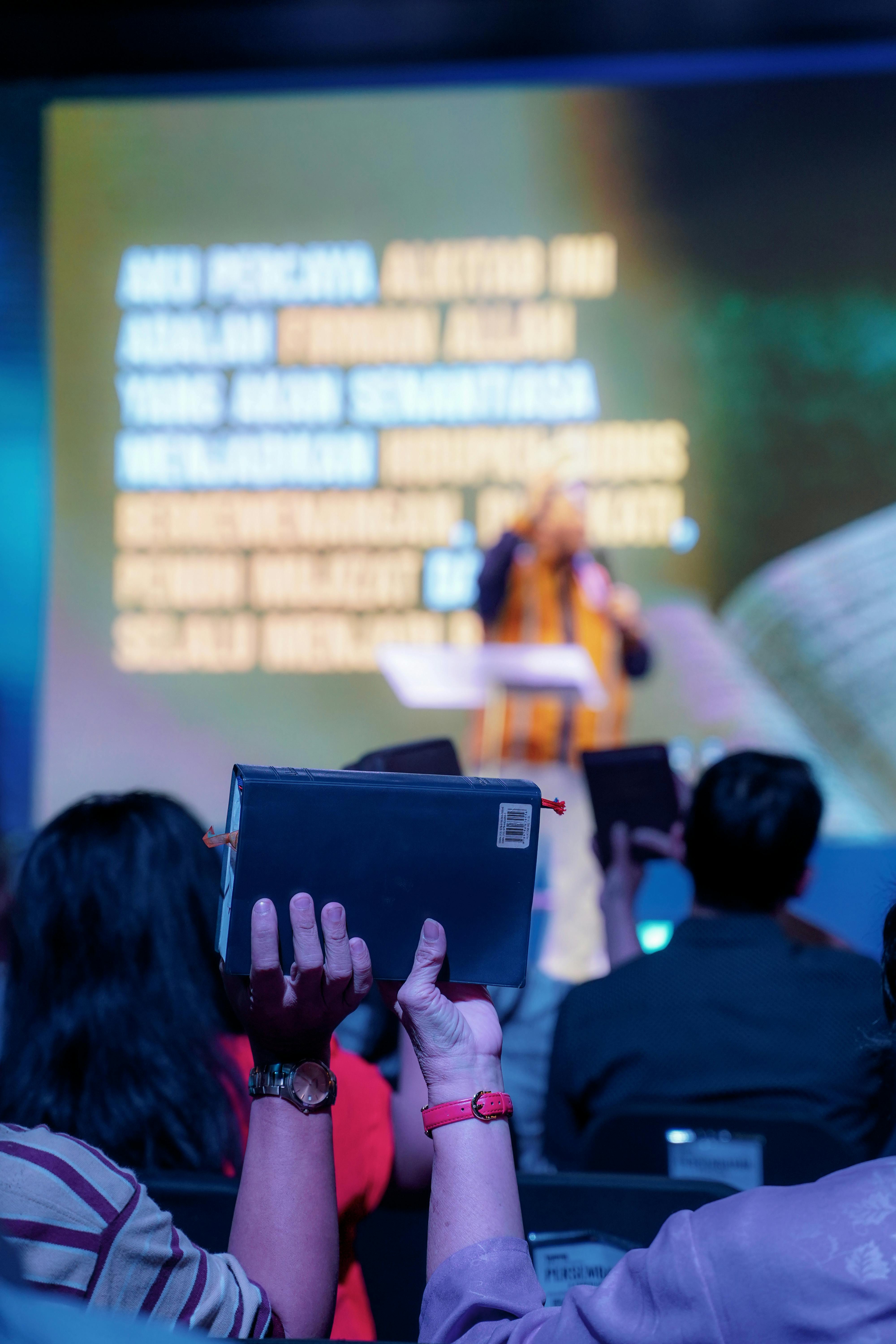 Congregation Holding Bible at Worship Event in Jakarta · Free Stock Photo