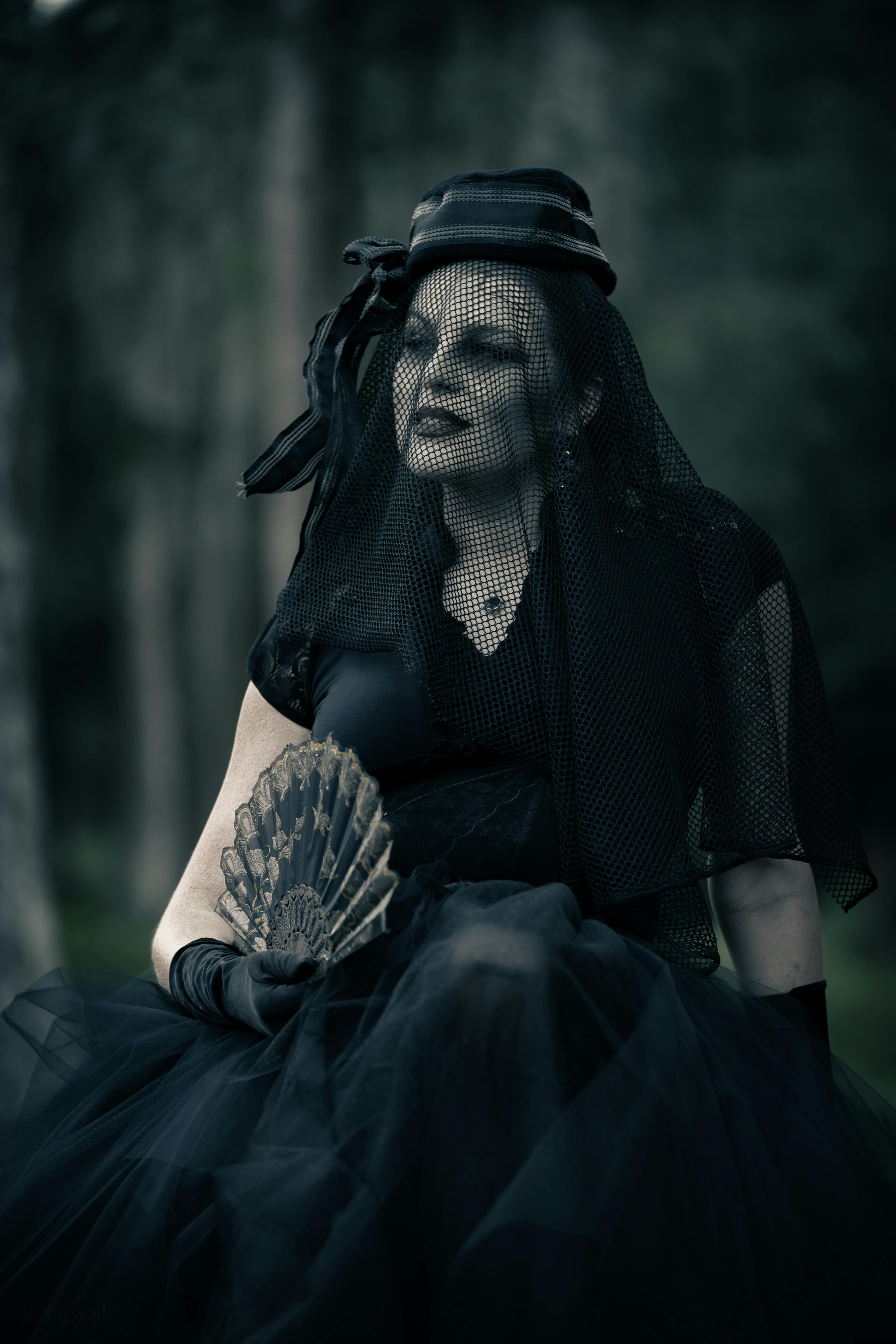 Elegant Woman in Gothic Attire with Fan Portrait · Free Stock Photo