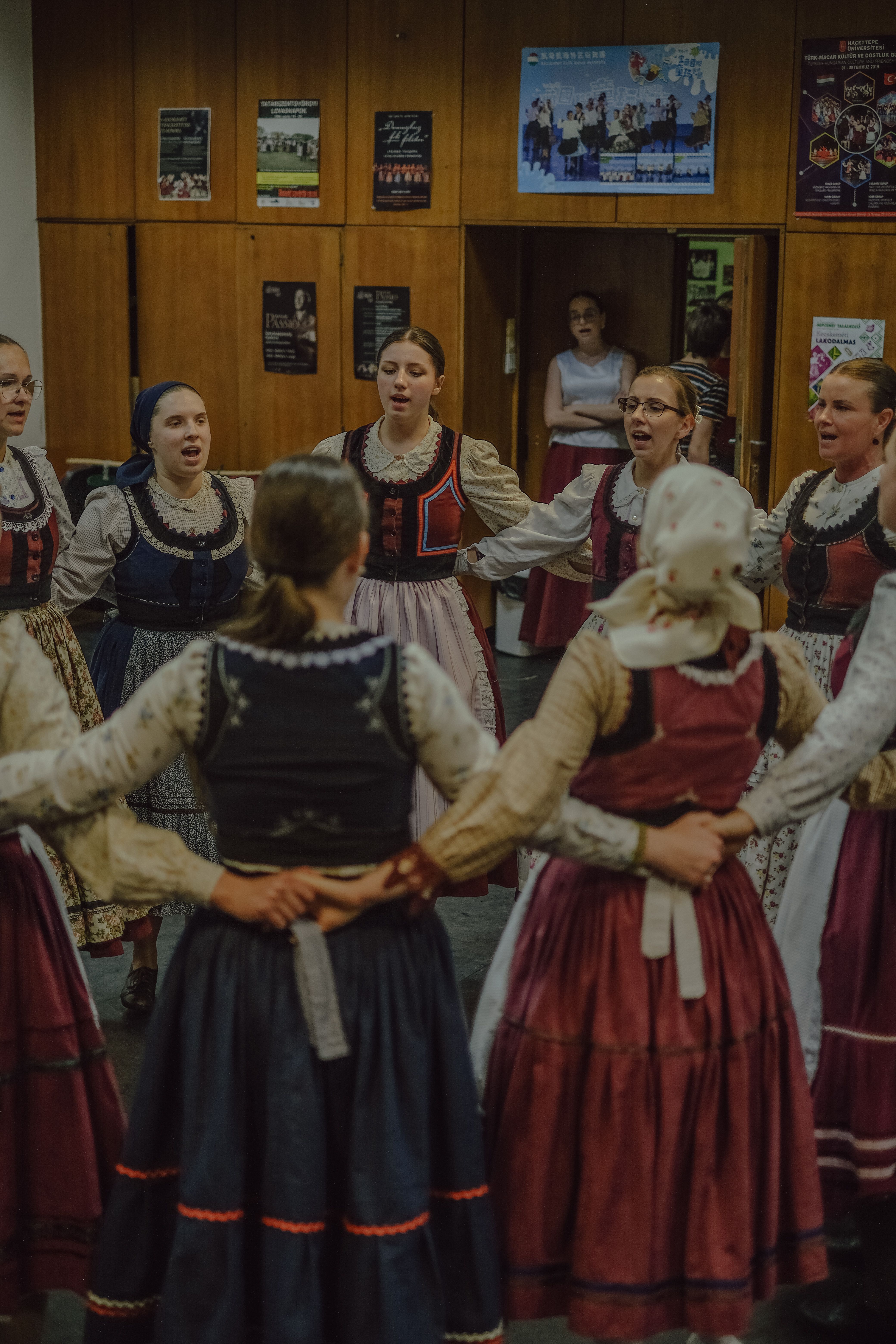 Women in Traditional Dance Circle Attire Indoors · Free Stock Photo