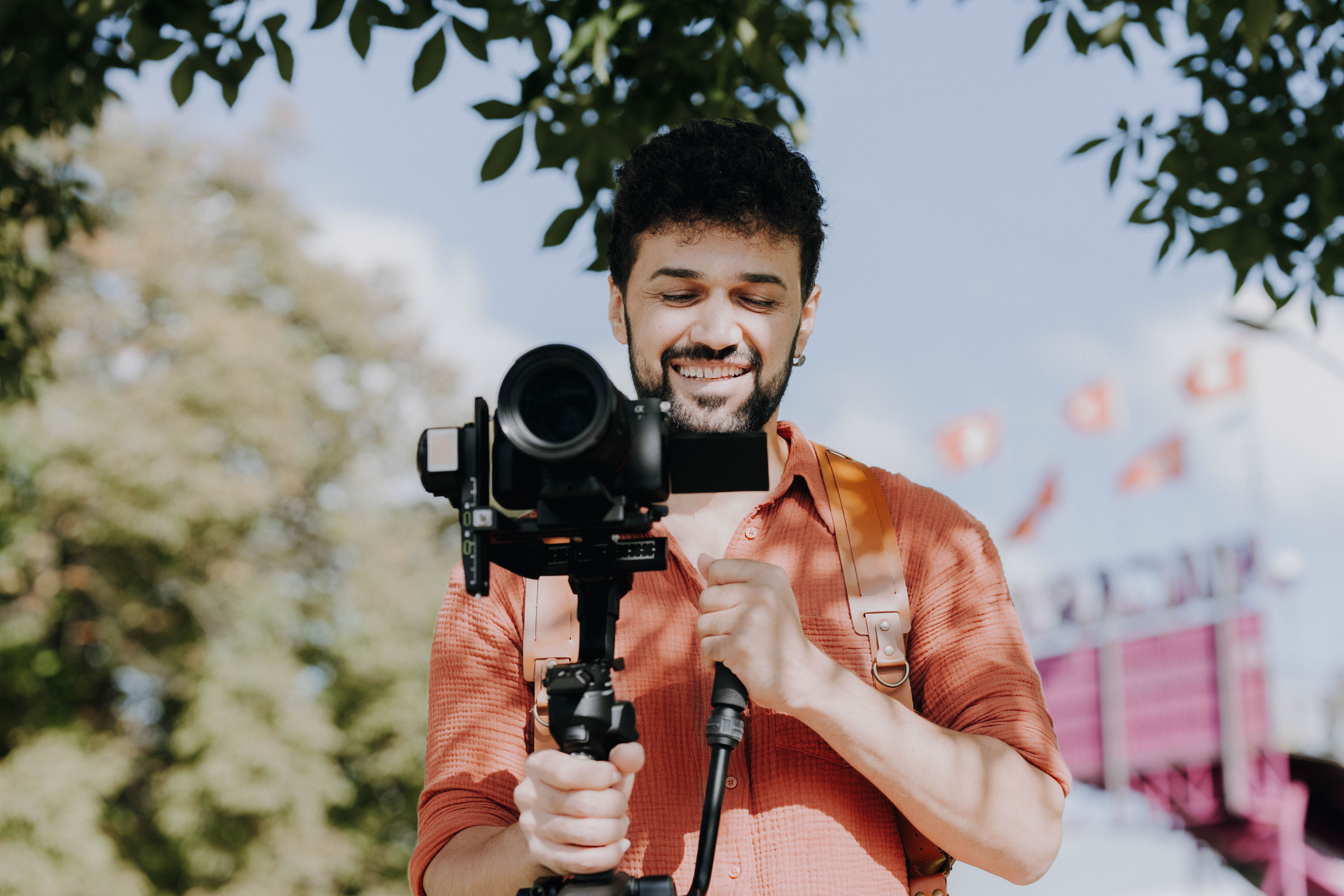 Cameraman Filming Outdoors with Gimbal · Free Stock Photo