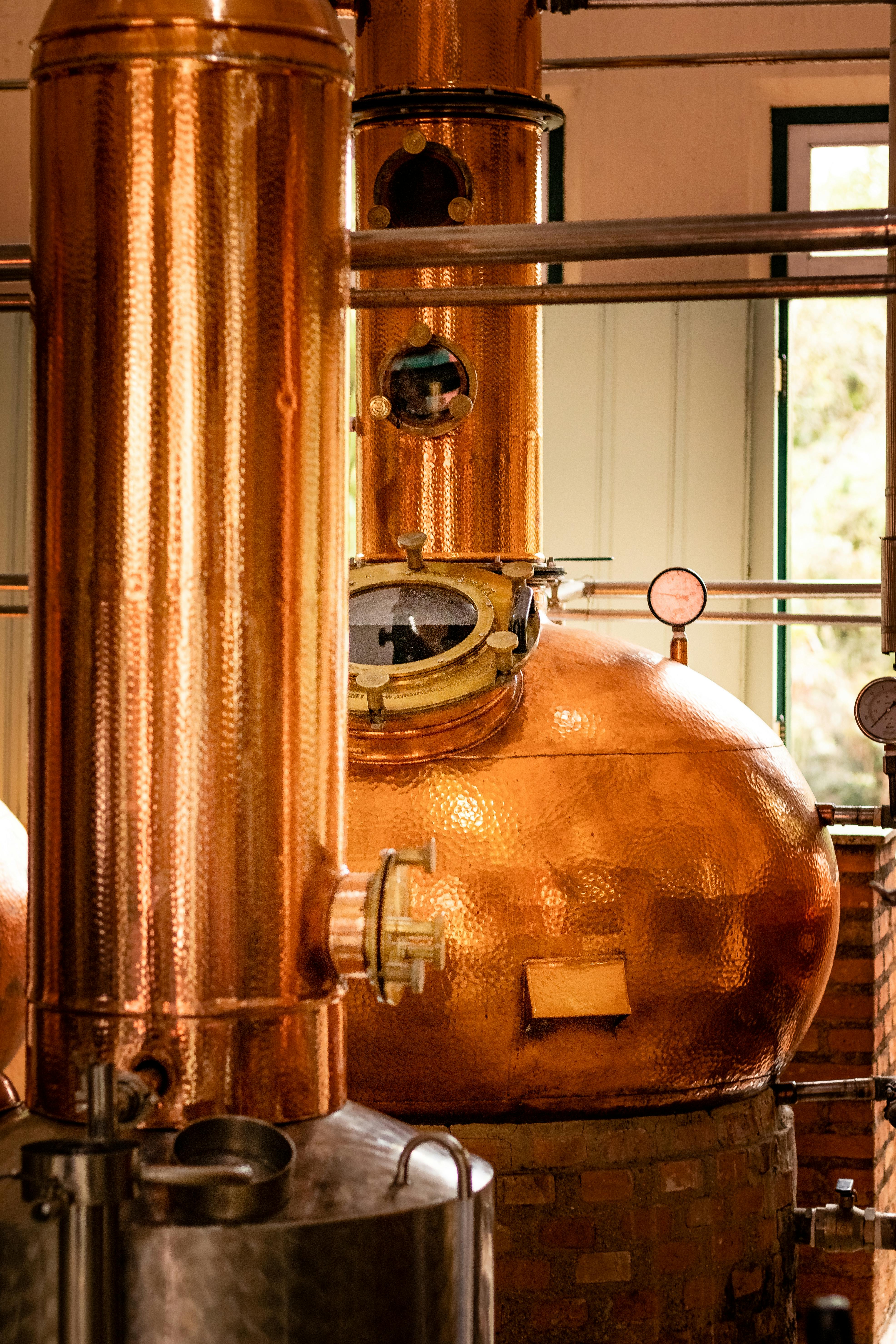 Copper Distilling Equipment Inside a Distillery · Free Stock Photo