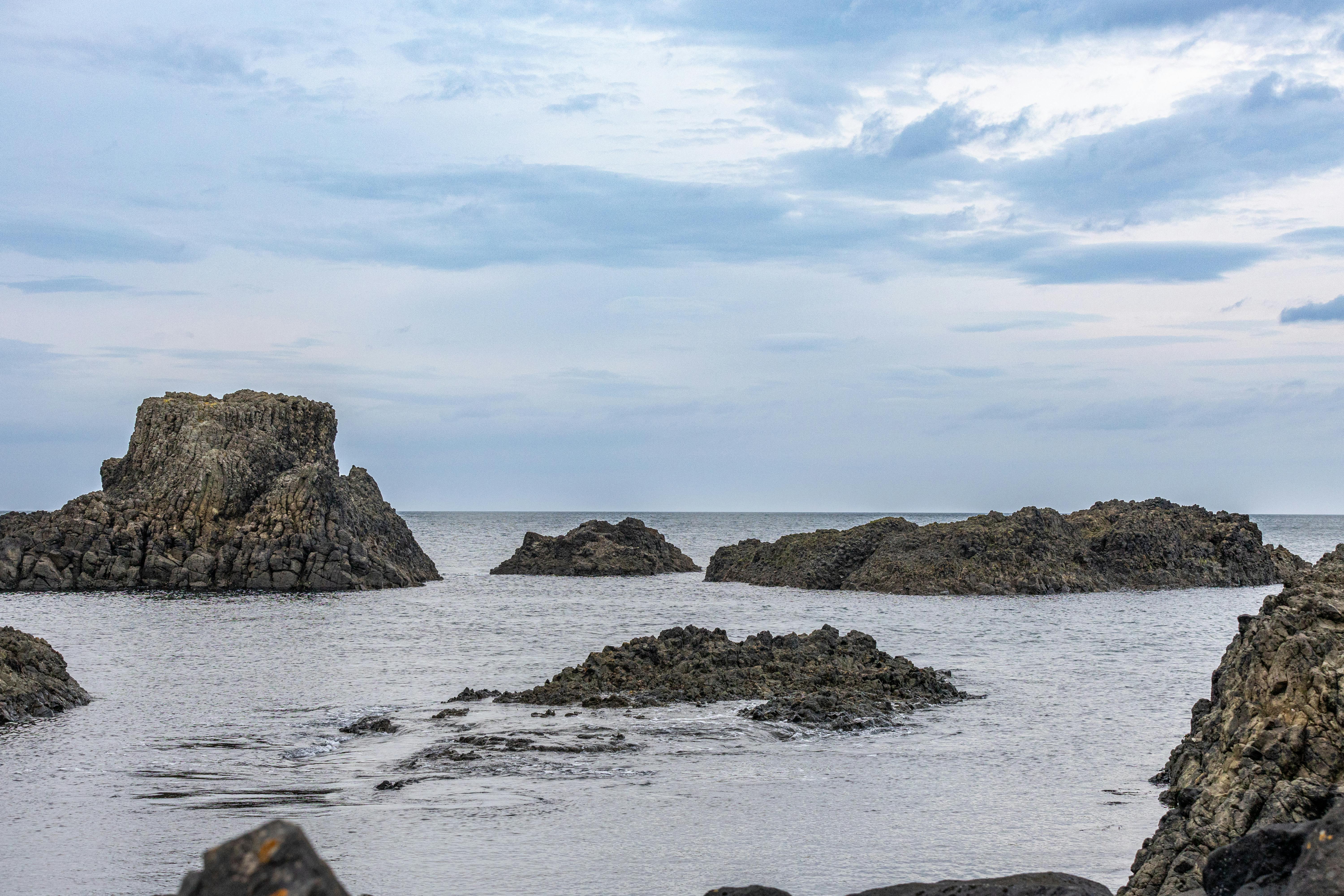 Rocky Coastal Landscape with Overcast Sky · Free Stock Photo