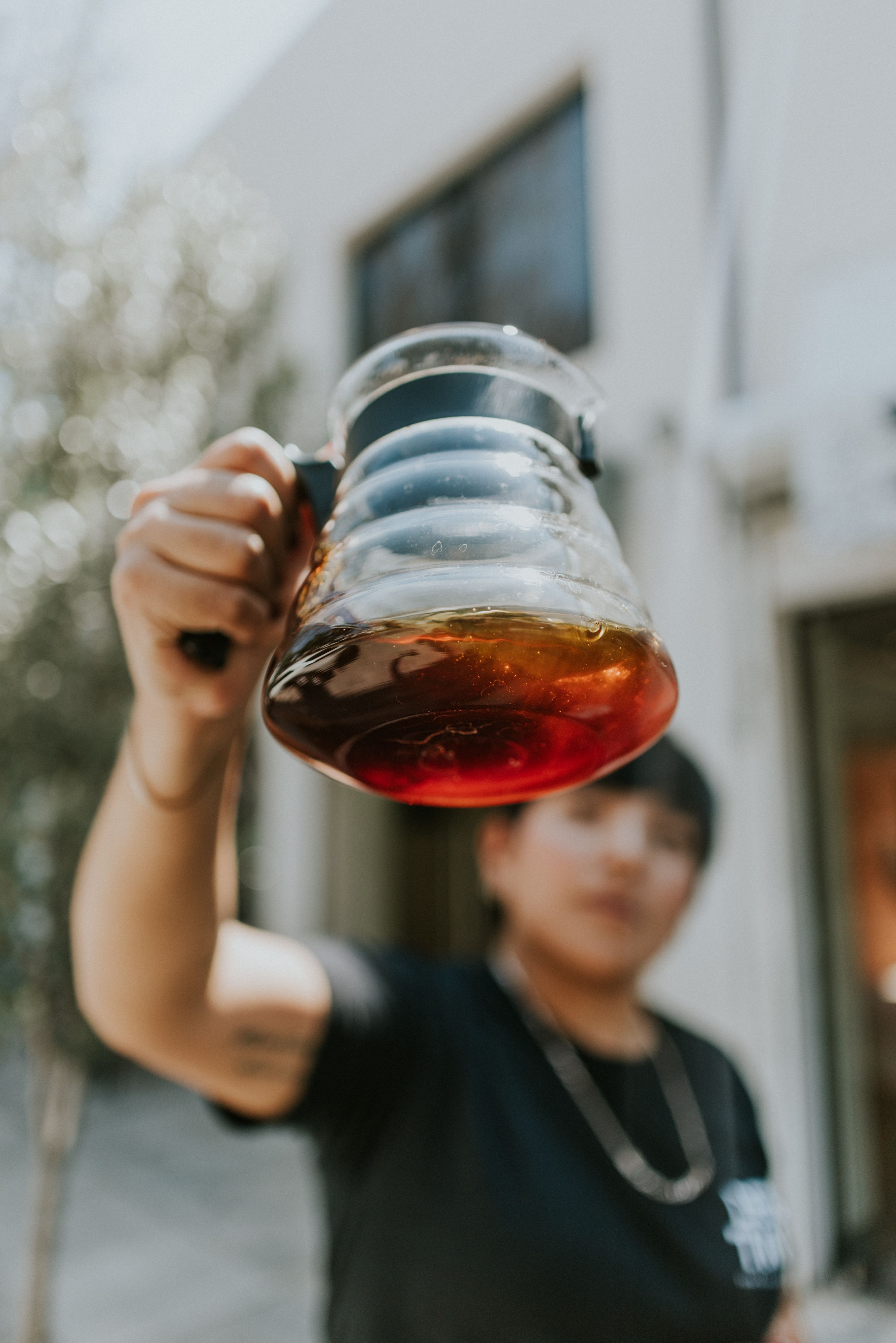 Close-Up of Coffee Pot Held in Focus · Free Stock Photo