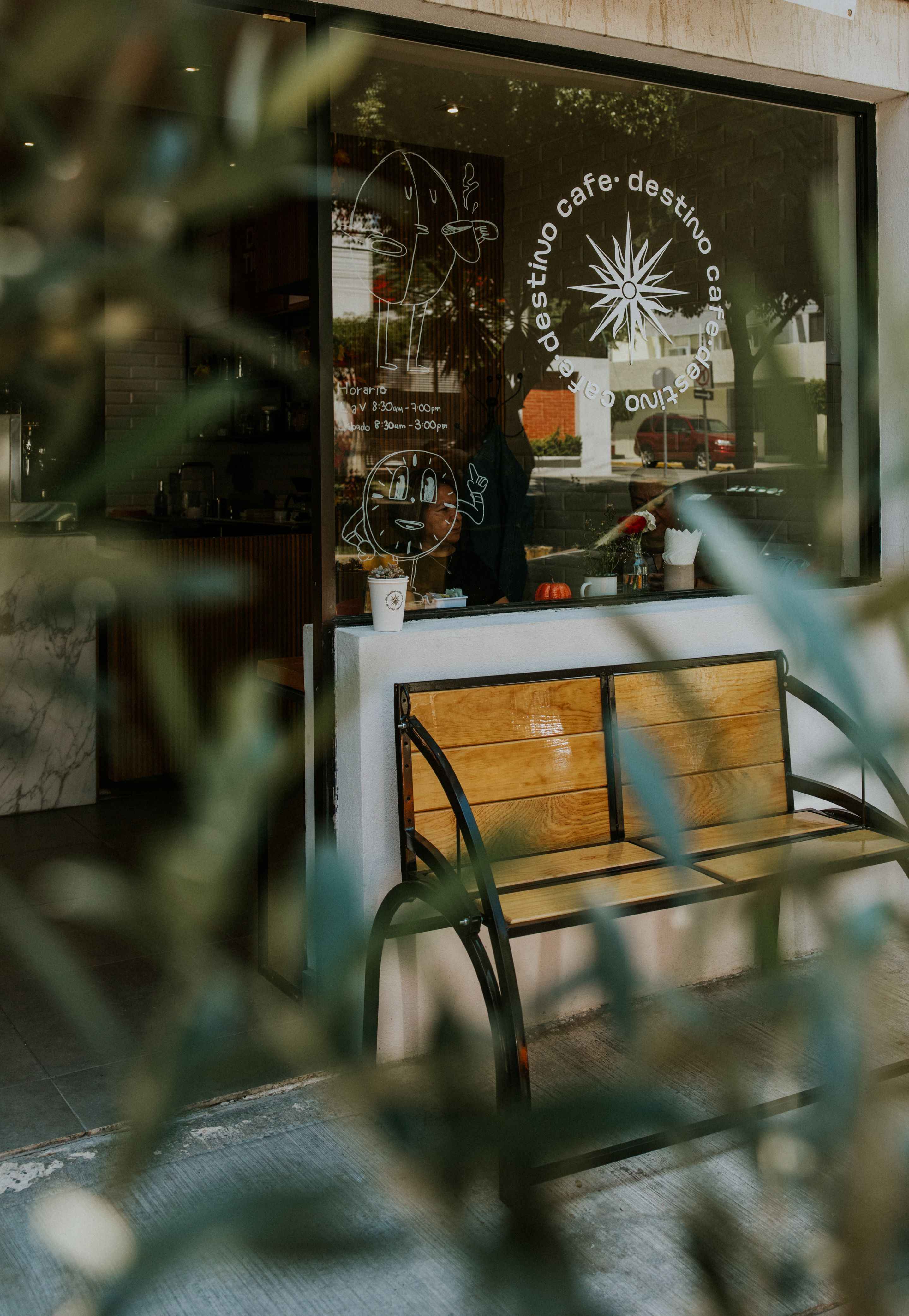 Charming Outdoor Cafe with Wooden Bench · Free Stock Photo