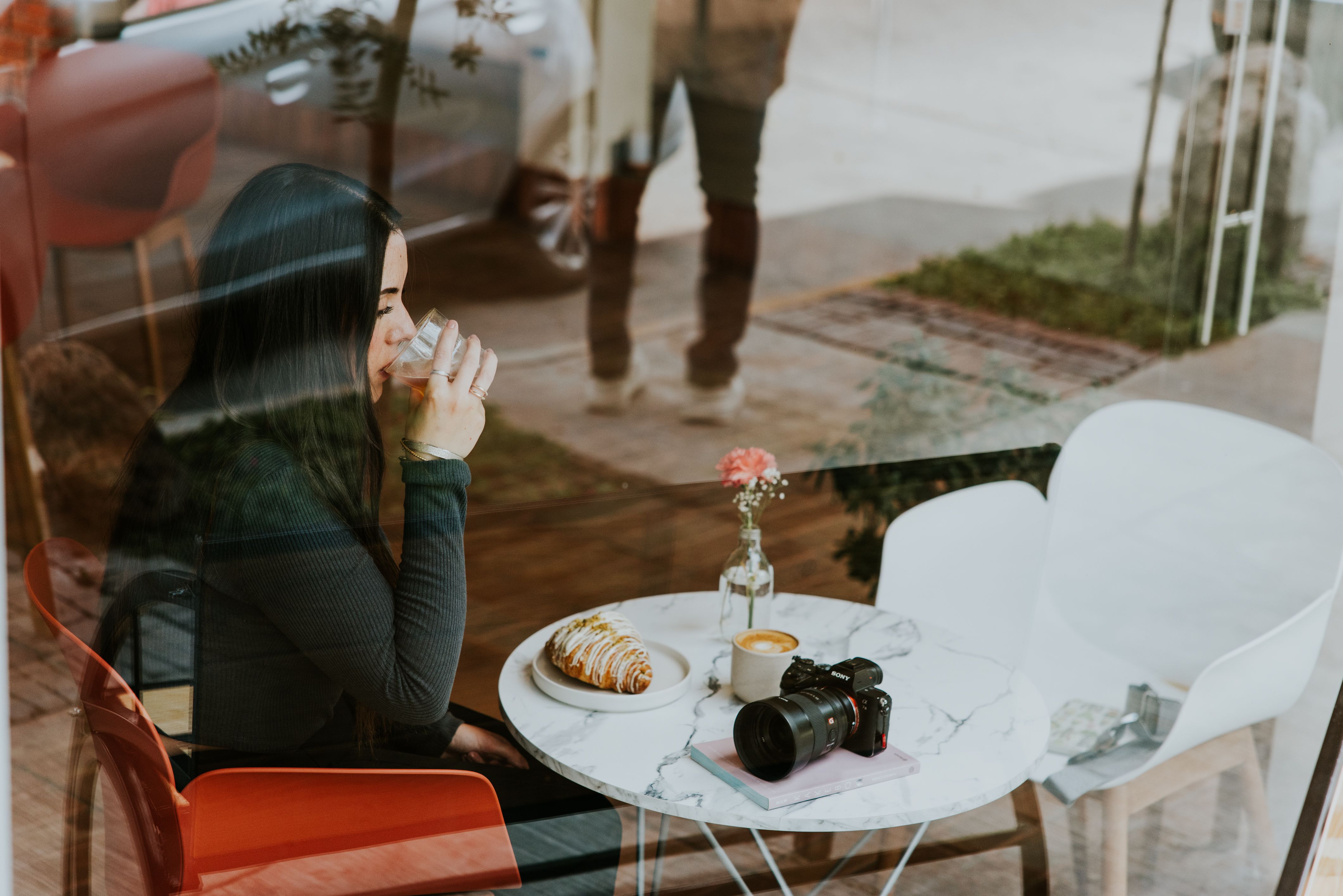 Woman Enjoying Coffee at a Cozy Cafe · Free Stock Photo