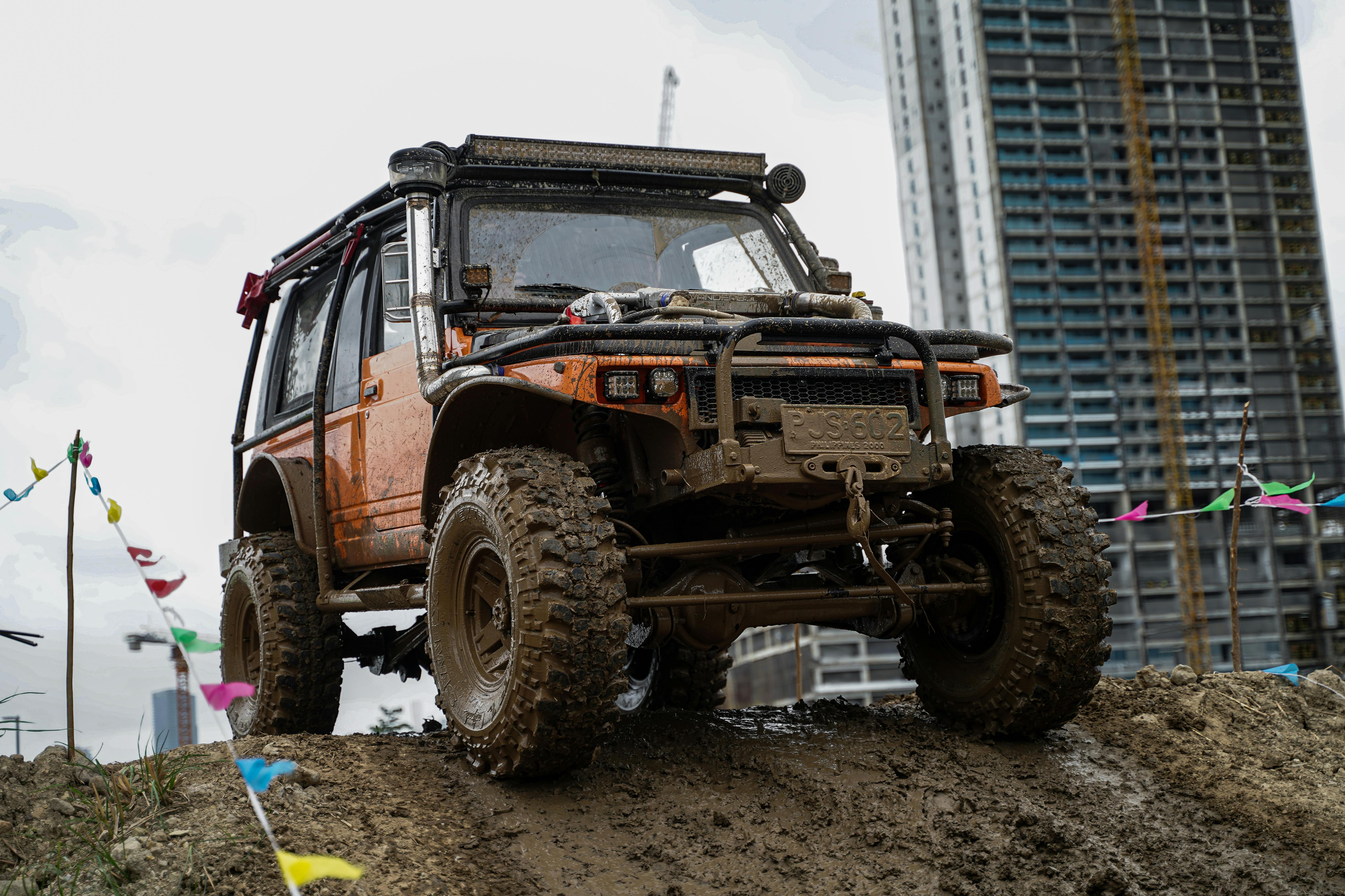 Off-road Vehicle on Muddy Terrain in Urban Area · Free Stock Photo