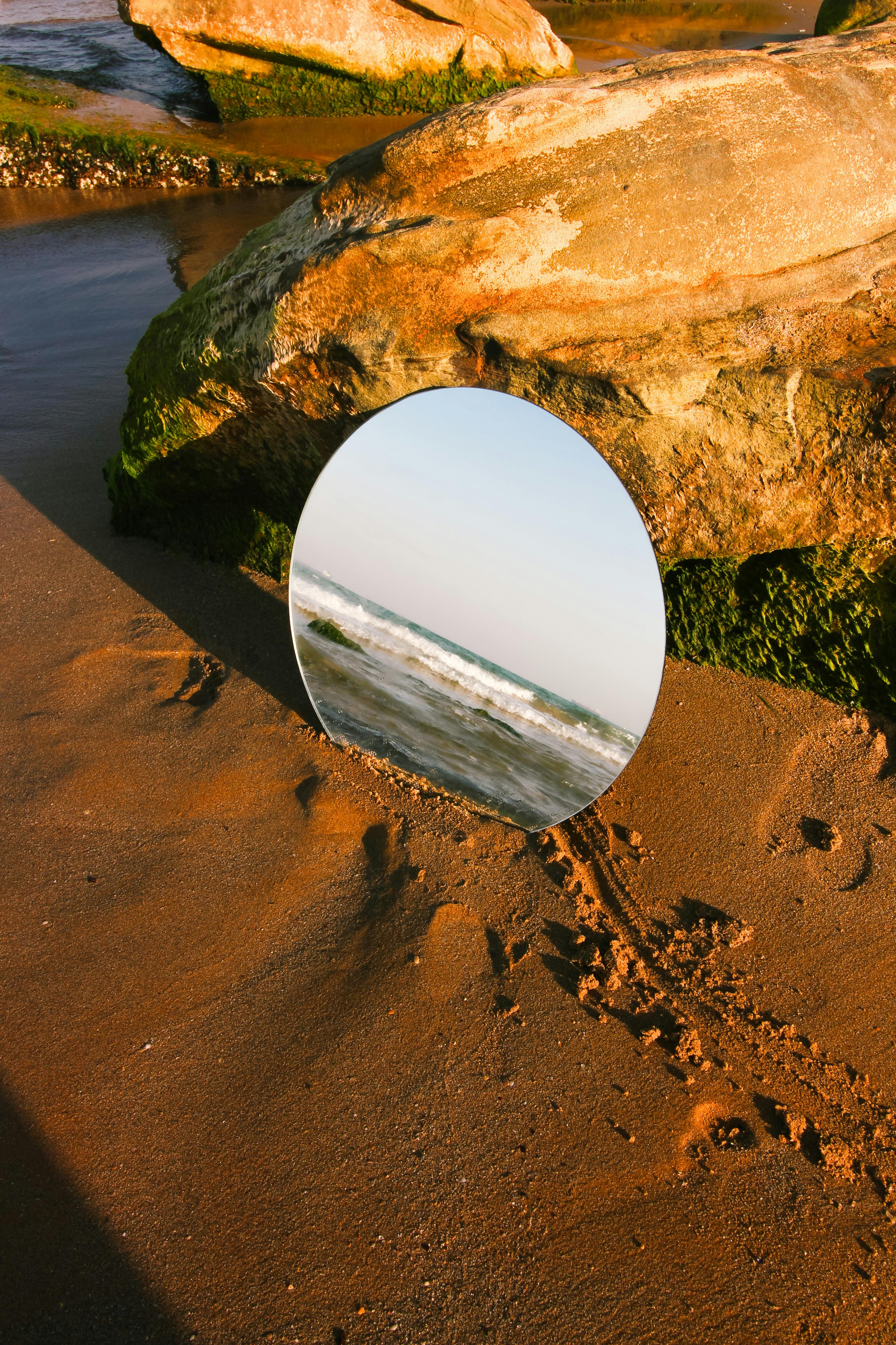 Reflected Ocean Waves on Sandy Beach with Rocks · Free Stock Photo