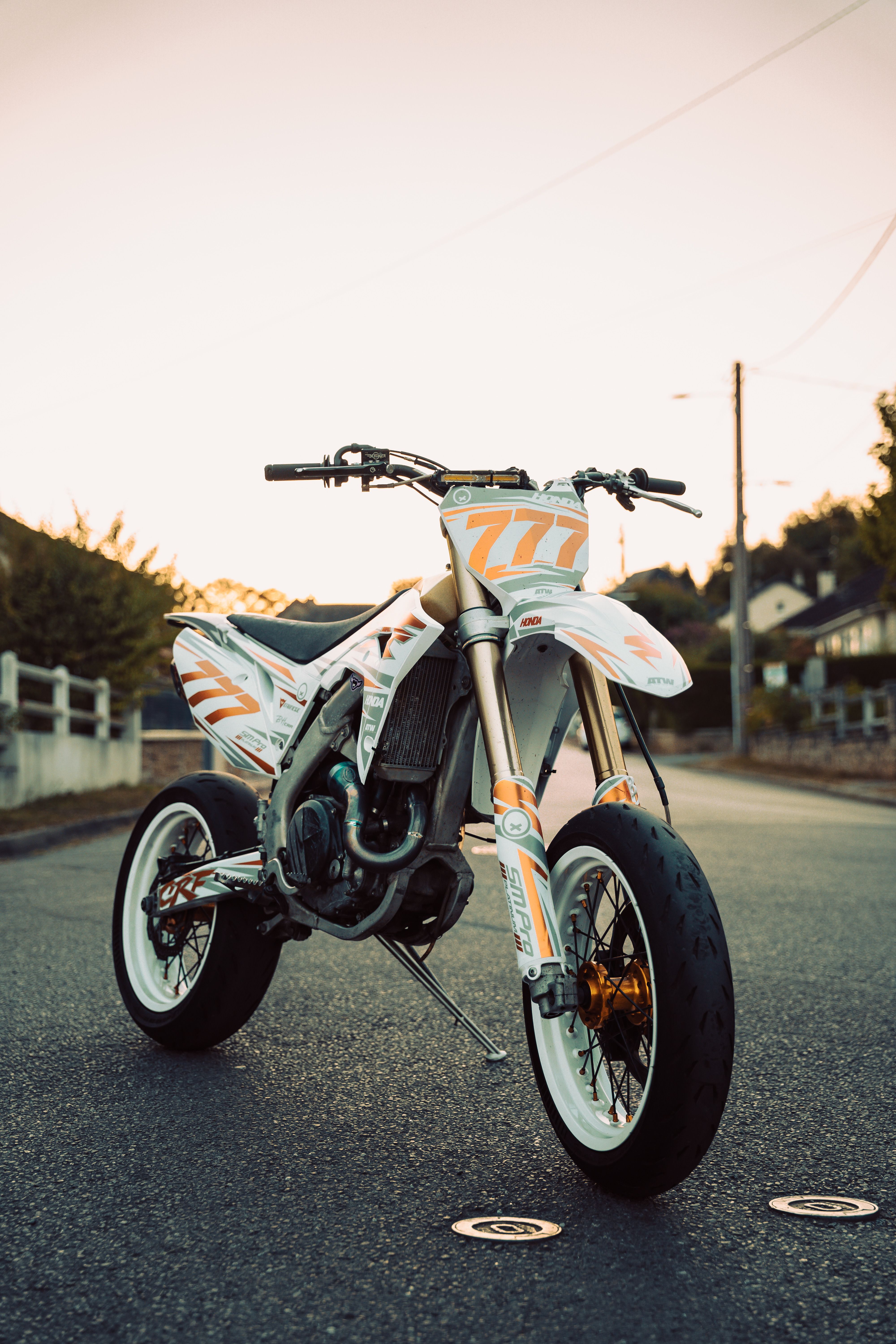 Supermoto Motorcycle on Quiet Suburban Street · Free Stock Photo