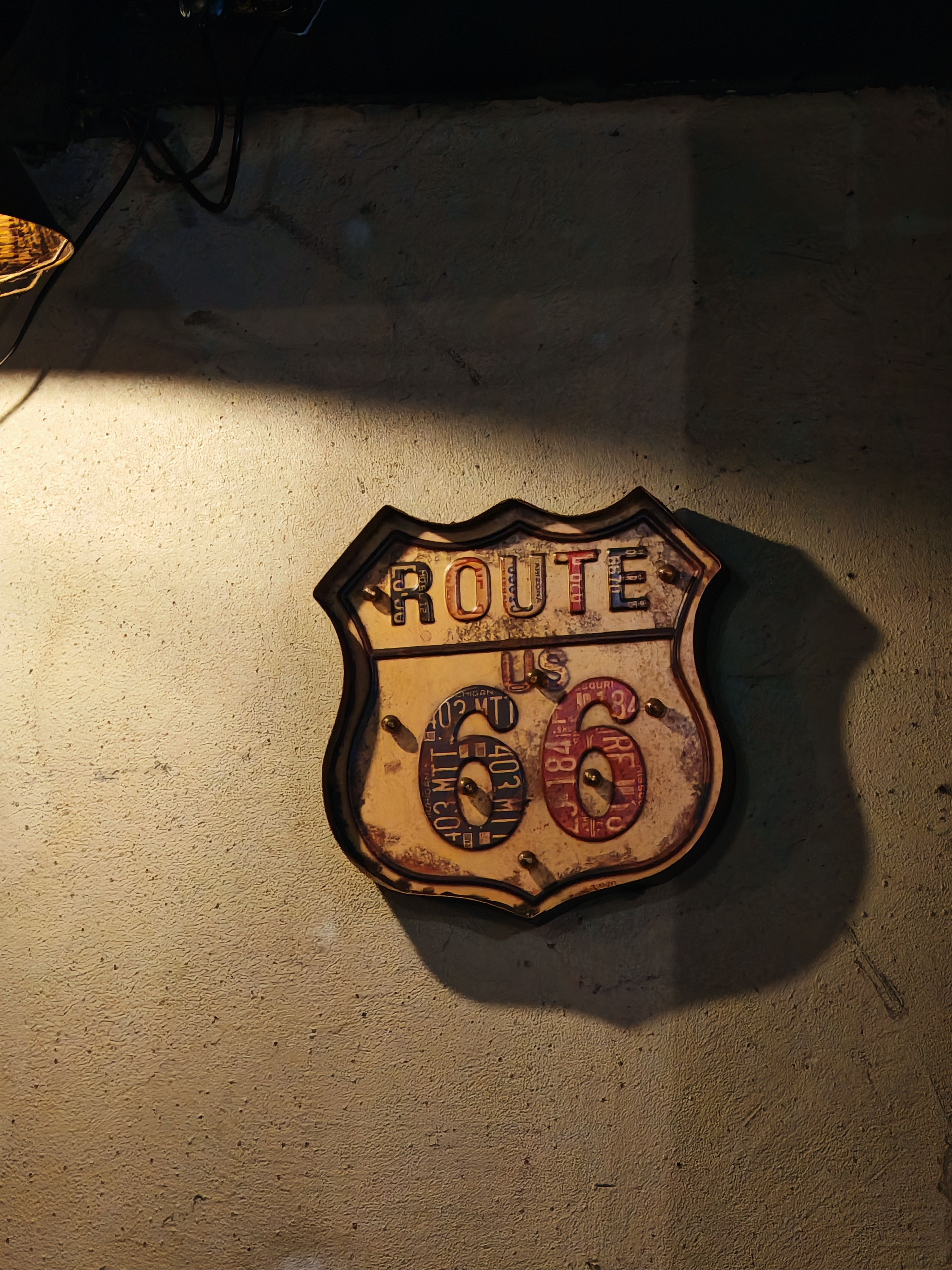 Vintage Route 66 Sign on Textured Wall · Free Stock Photo