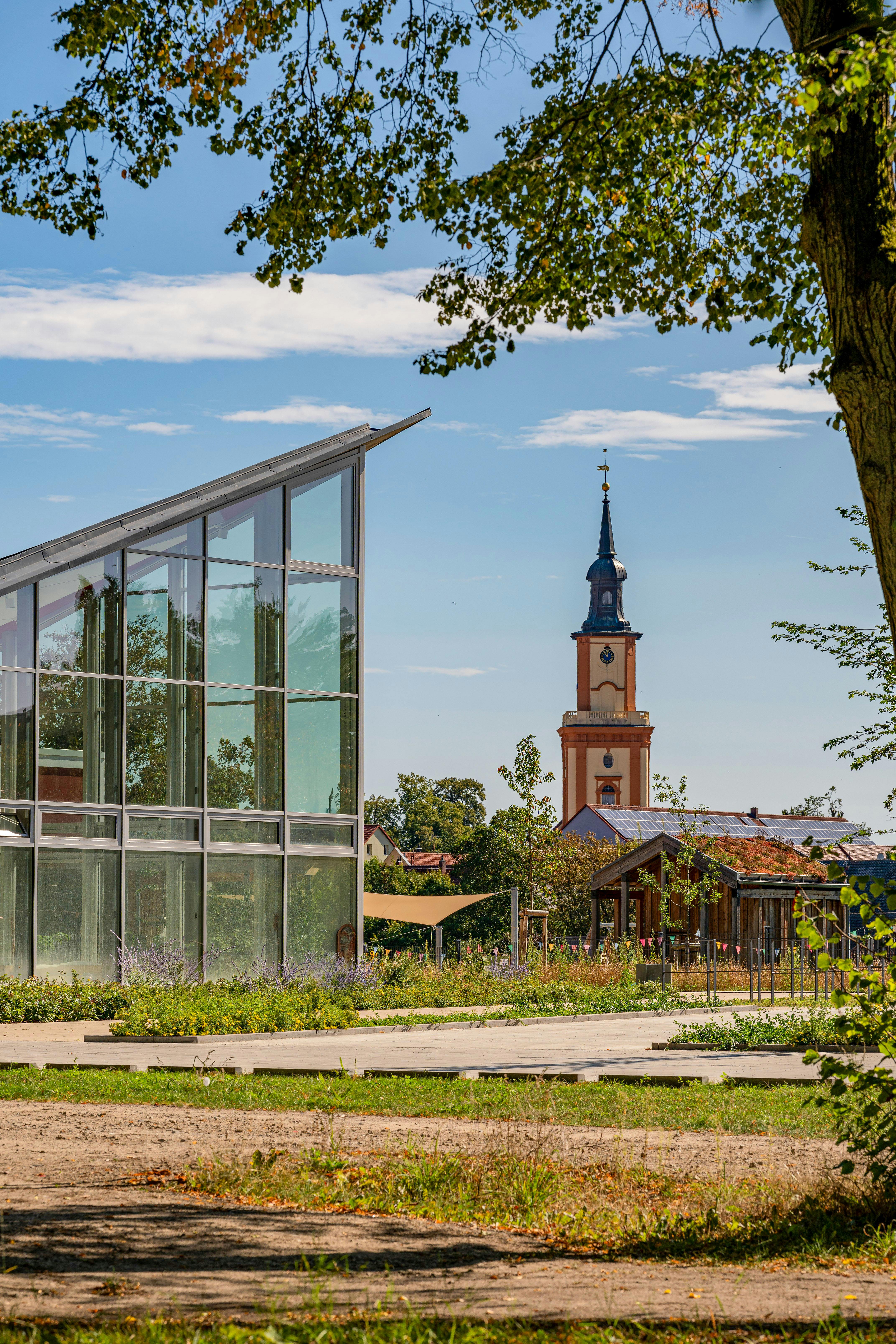 Modern Glass Building and Historic Church Tower · Free Stock Photo