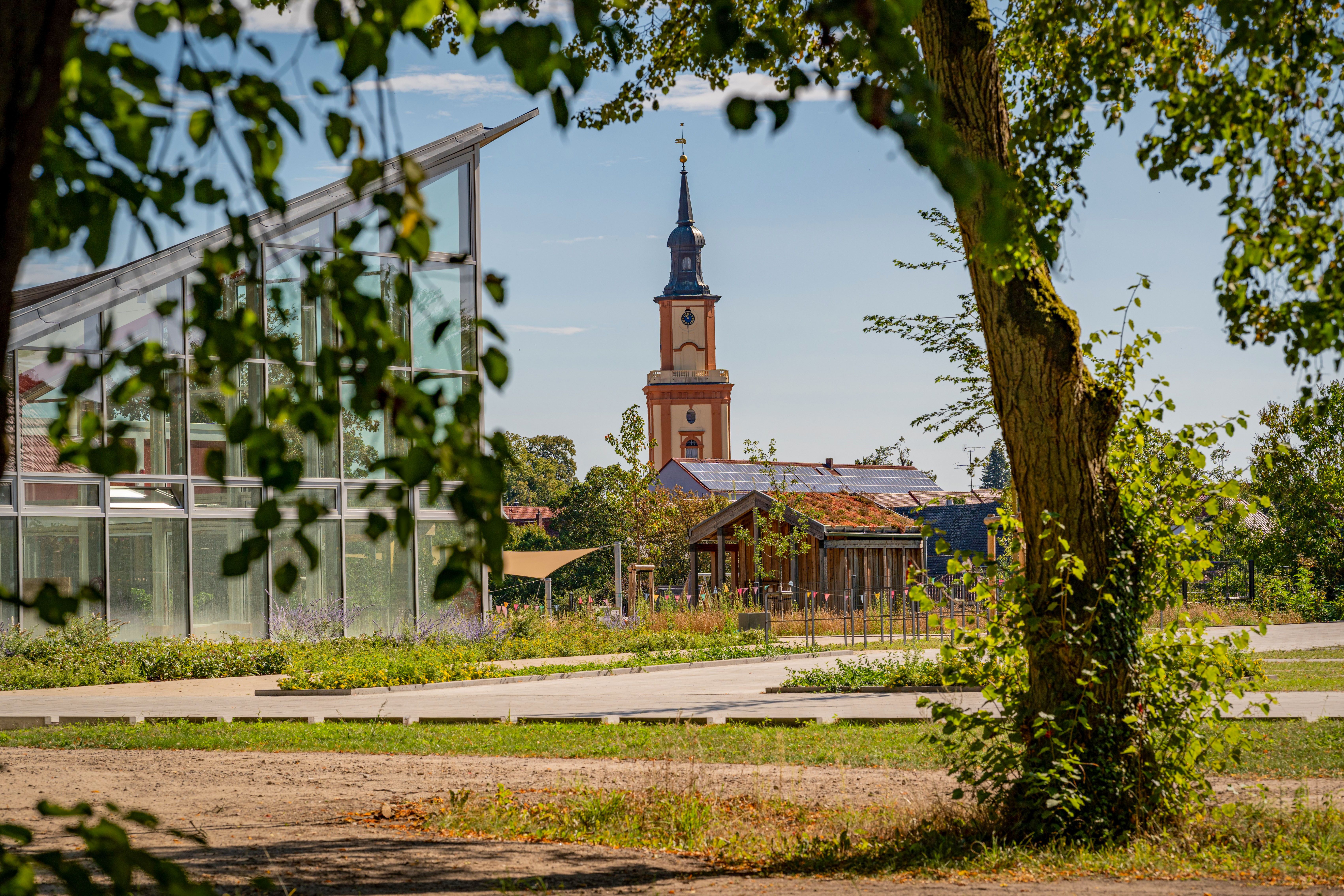 Historic Church Spire with Modern Glass Building · Free Stock Photo