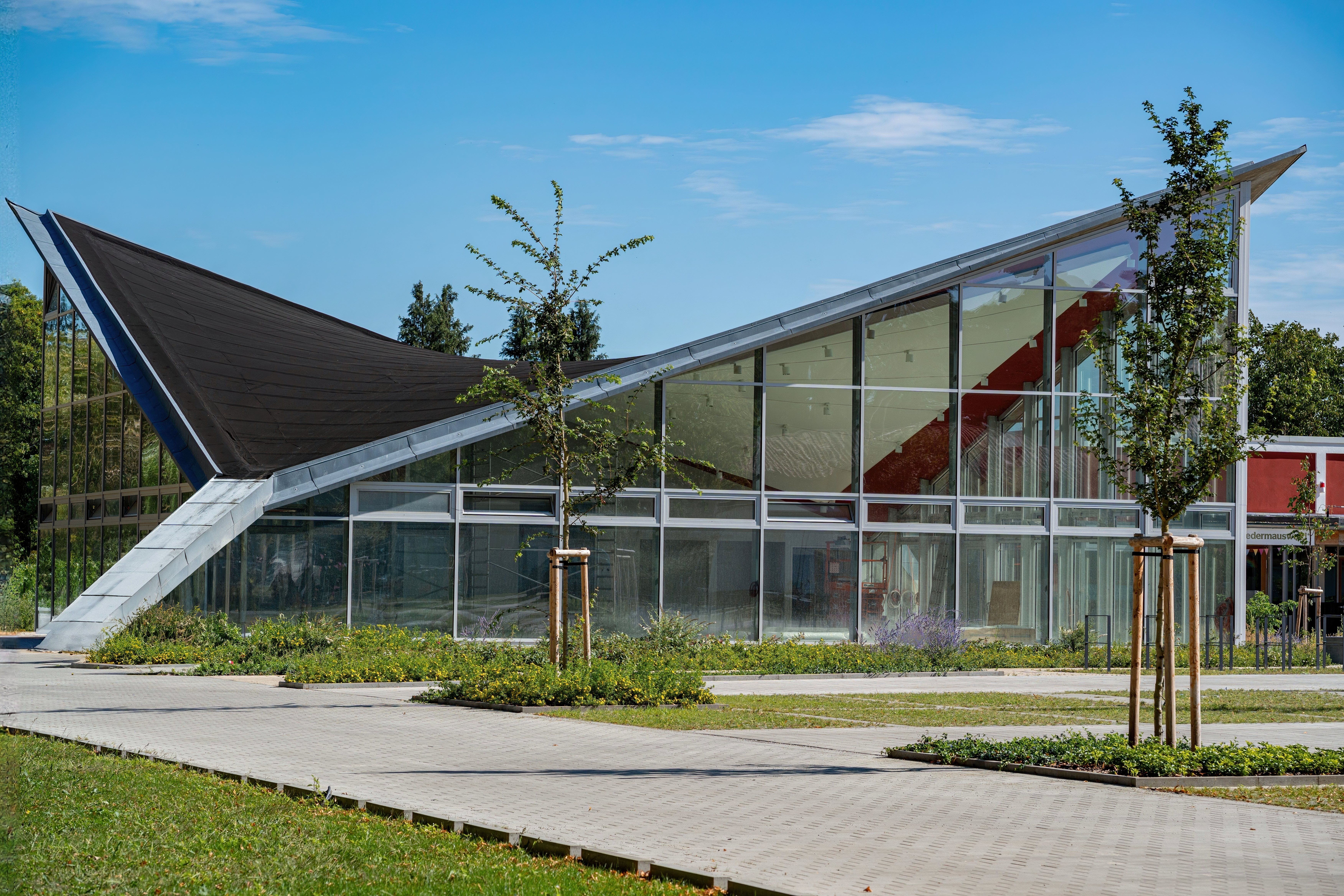 Modern Glass Building with Unique Geometric Roof · Free Stock Photo
