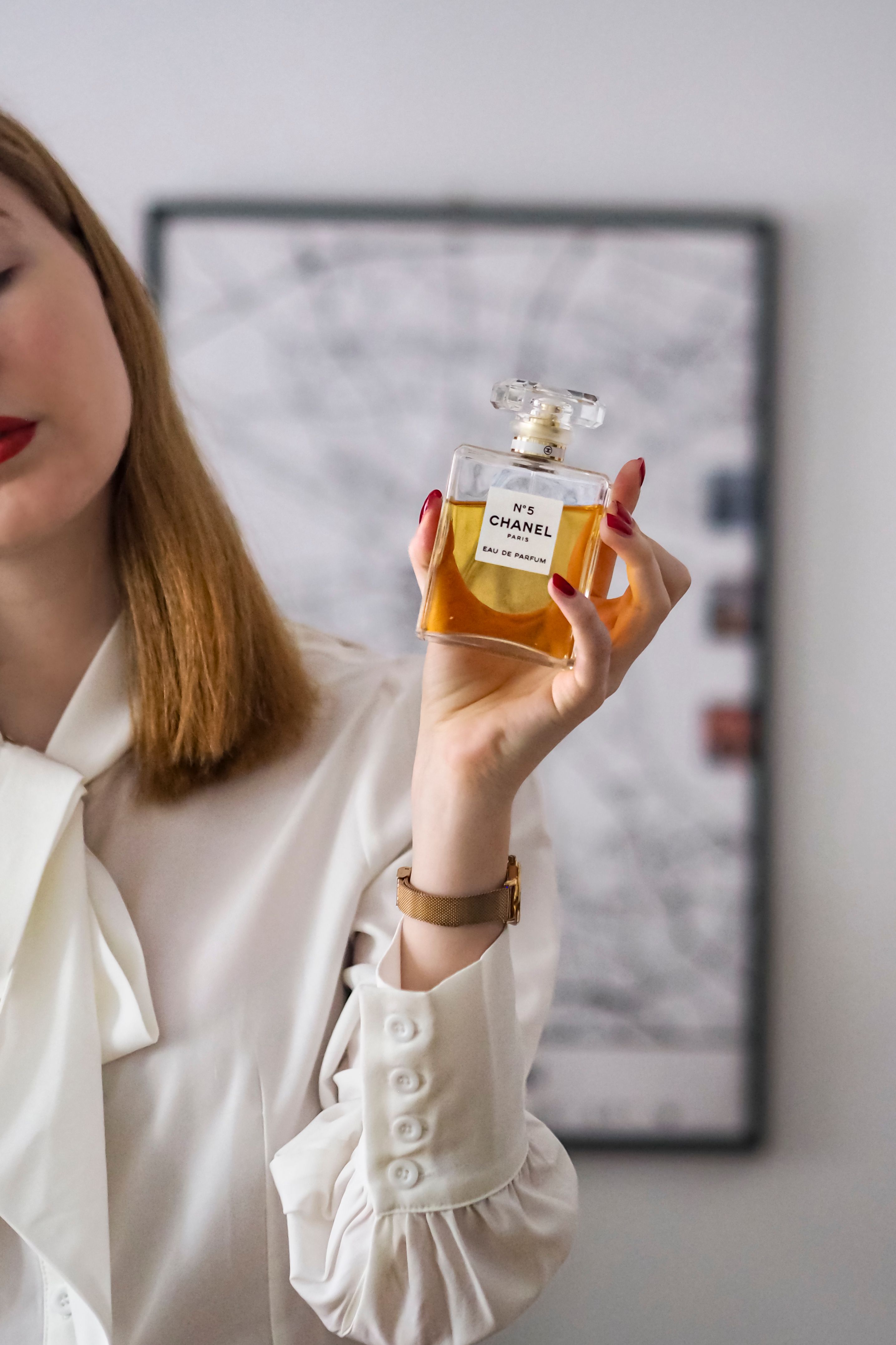 Elegant Woman Holding Iconic Perfume Bottle · Free Stock Photo