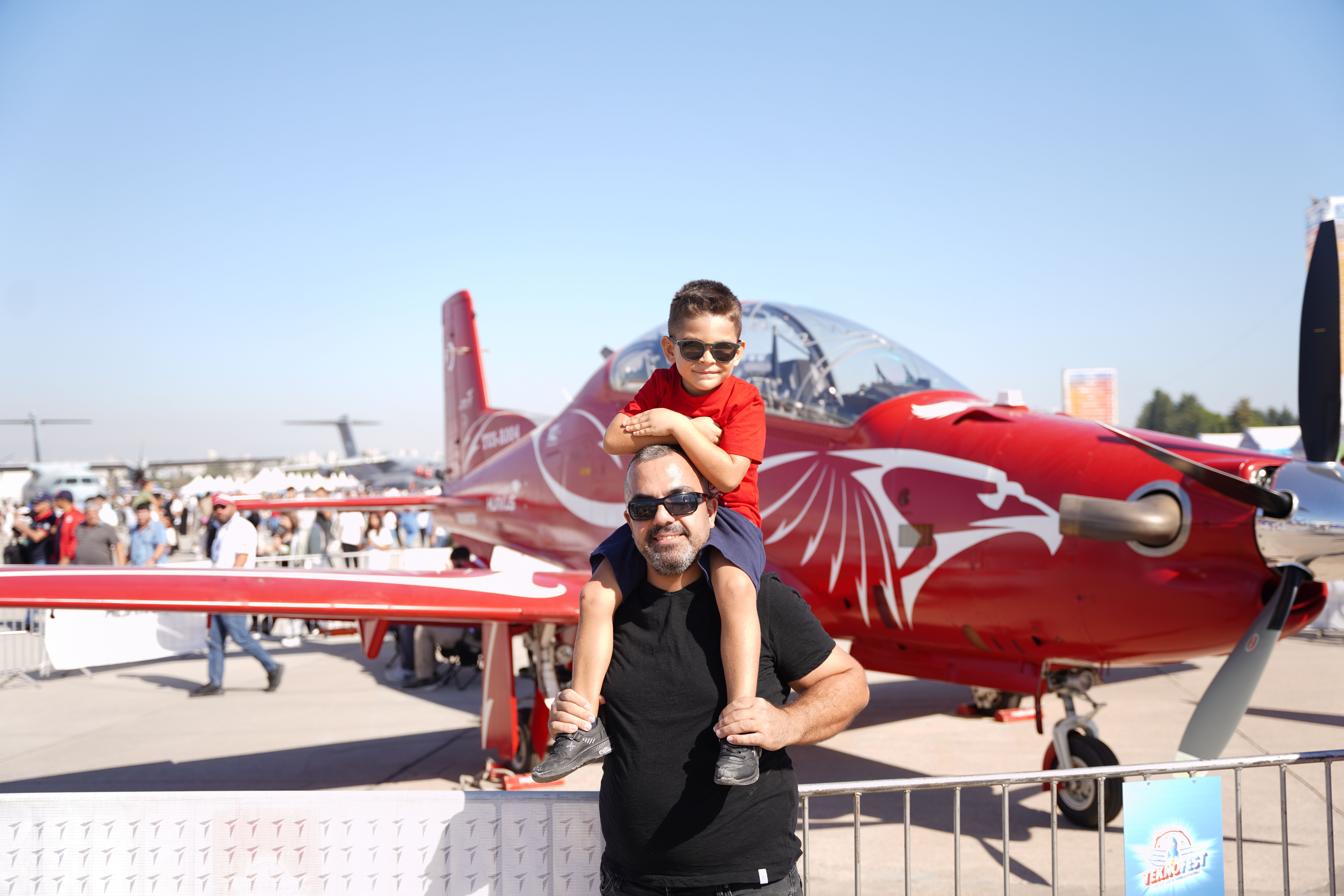 Family Enjoying Air Show with Red Aerobatic Plane in Adana · Free Stock ...