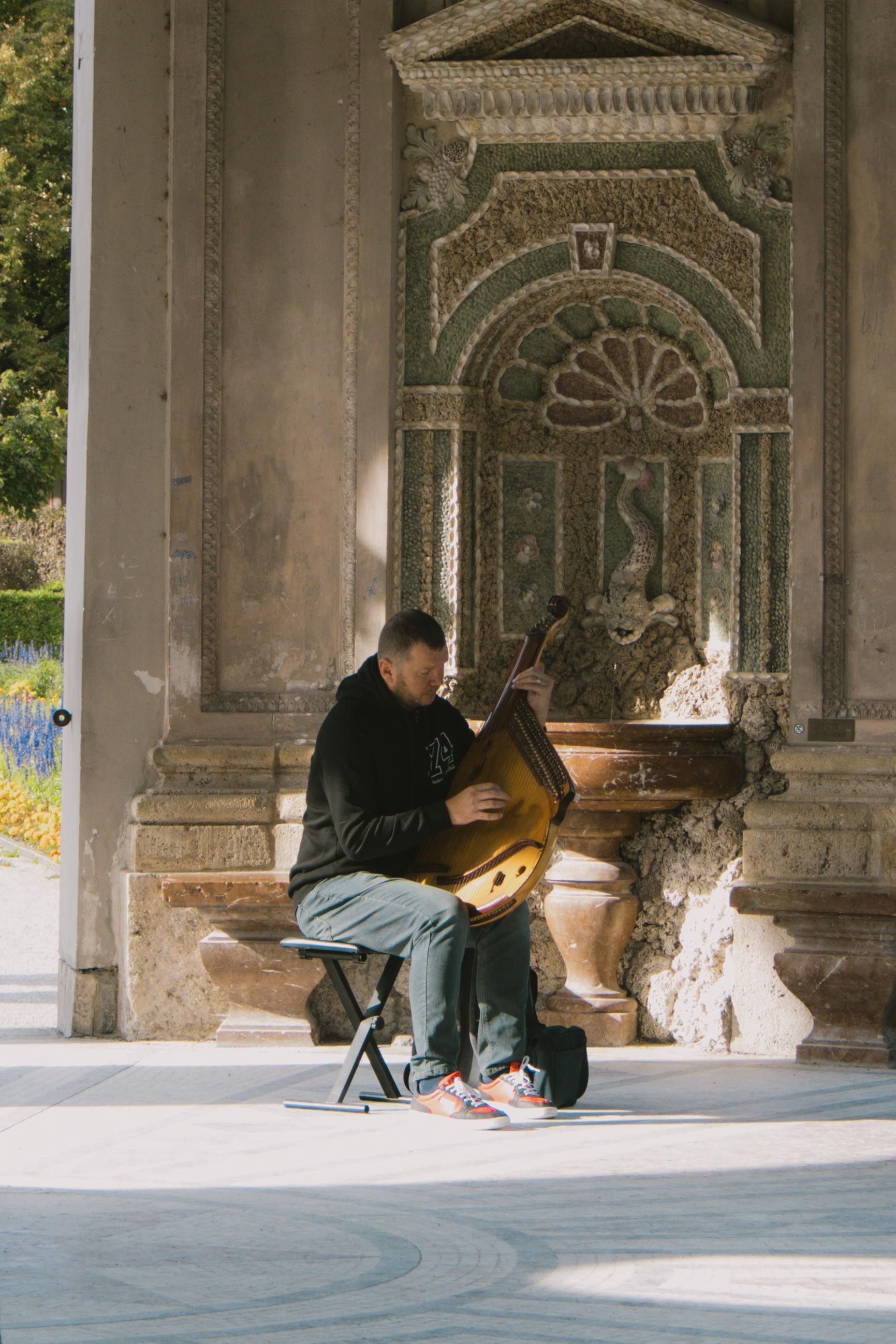Street Musician Playing Traditional Instrument · Free Stock Photo