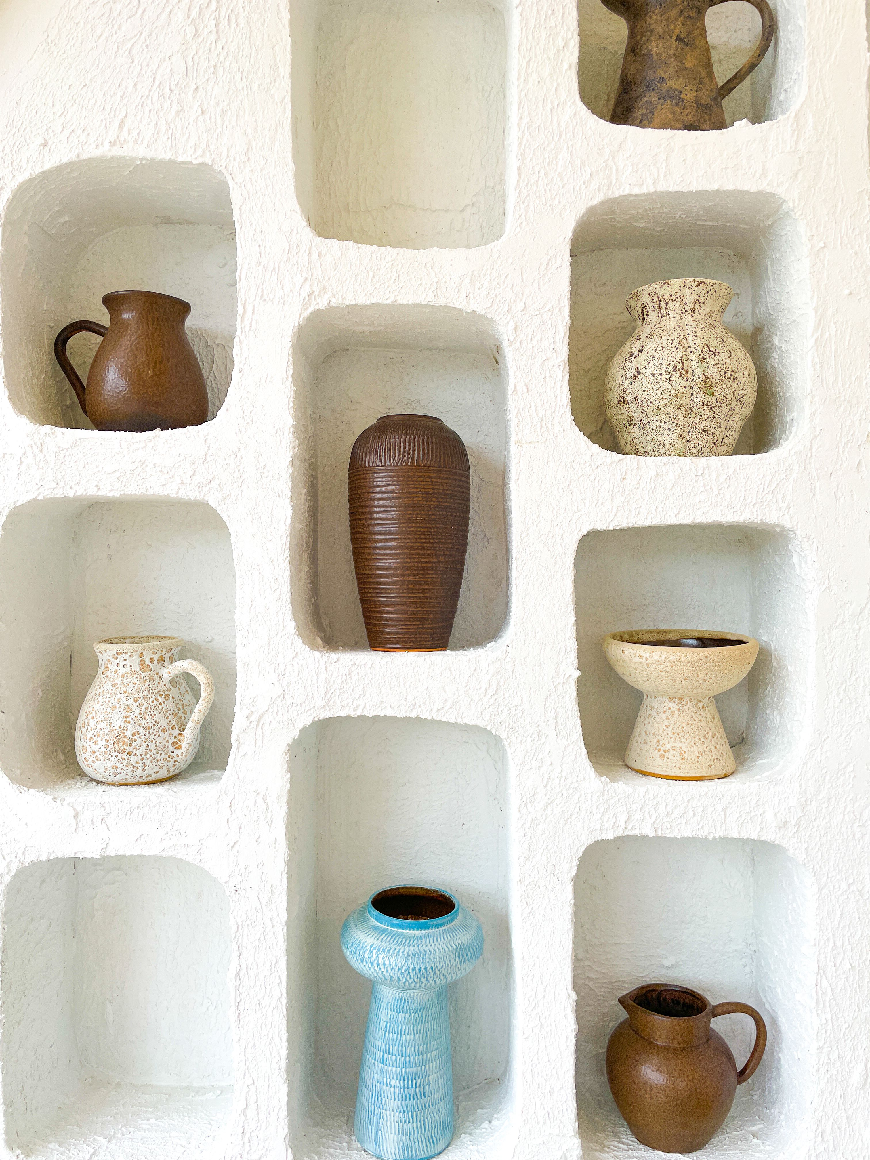 Rustic Pottery Display in Alcove Wall Shelves · Free Stock Photo