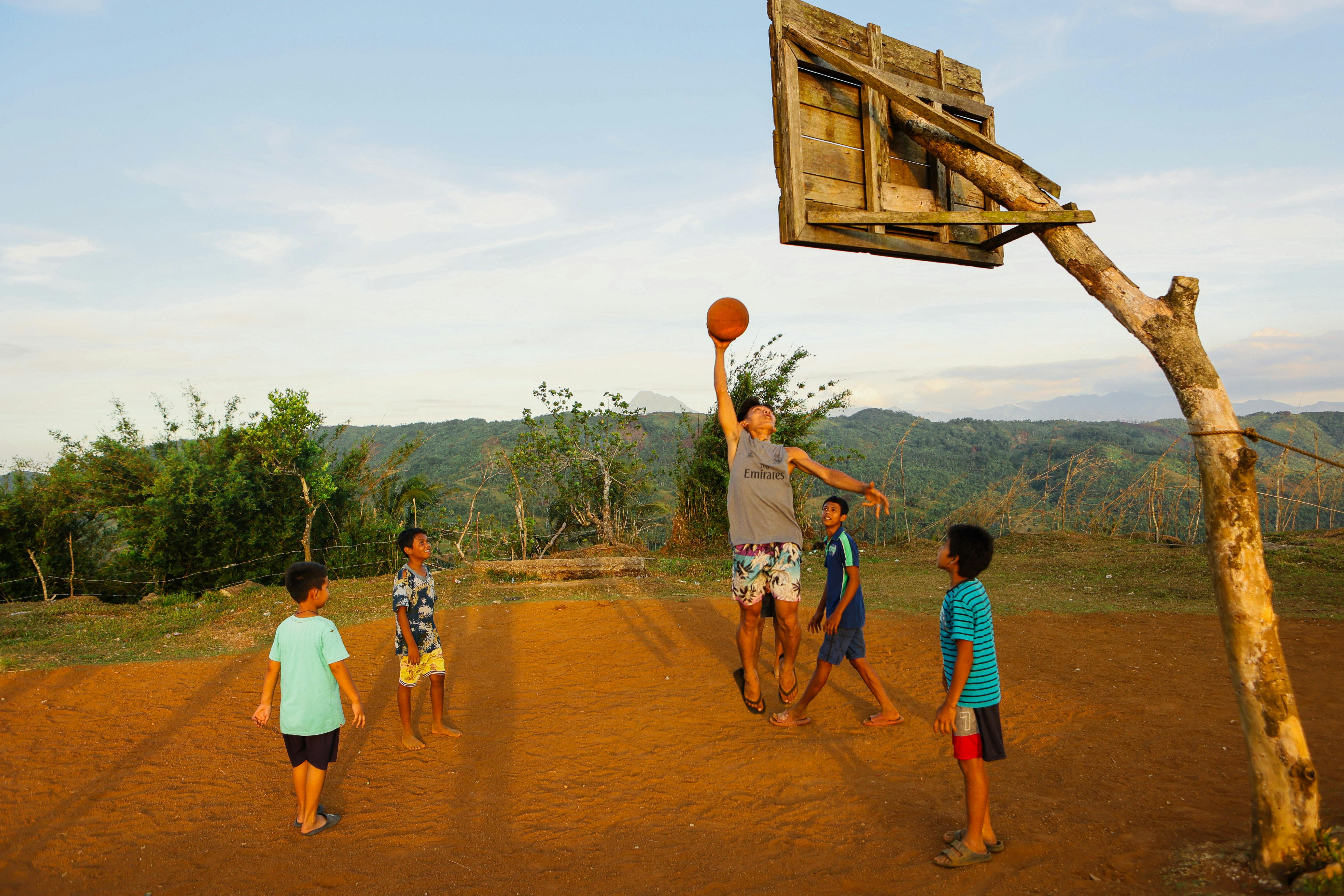 Kids Playing Basketball Outdoors in Rural Area · Free Stock Photo