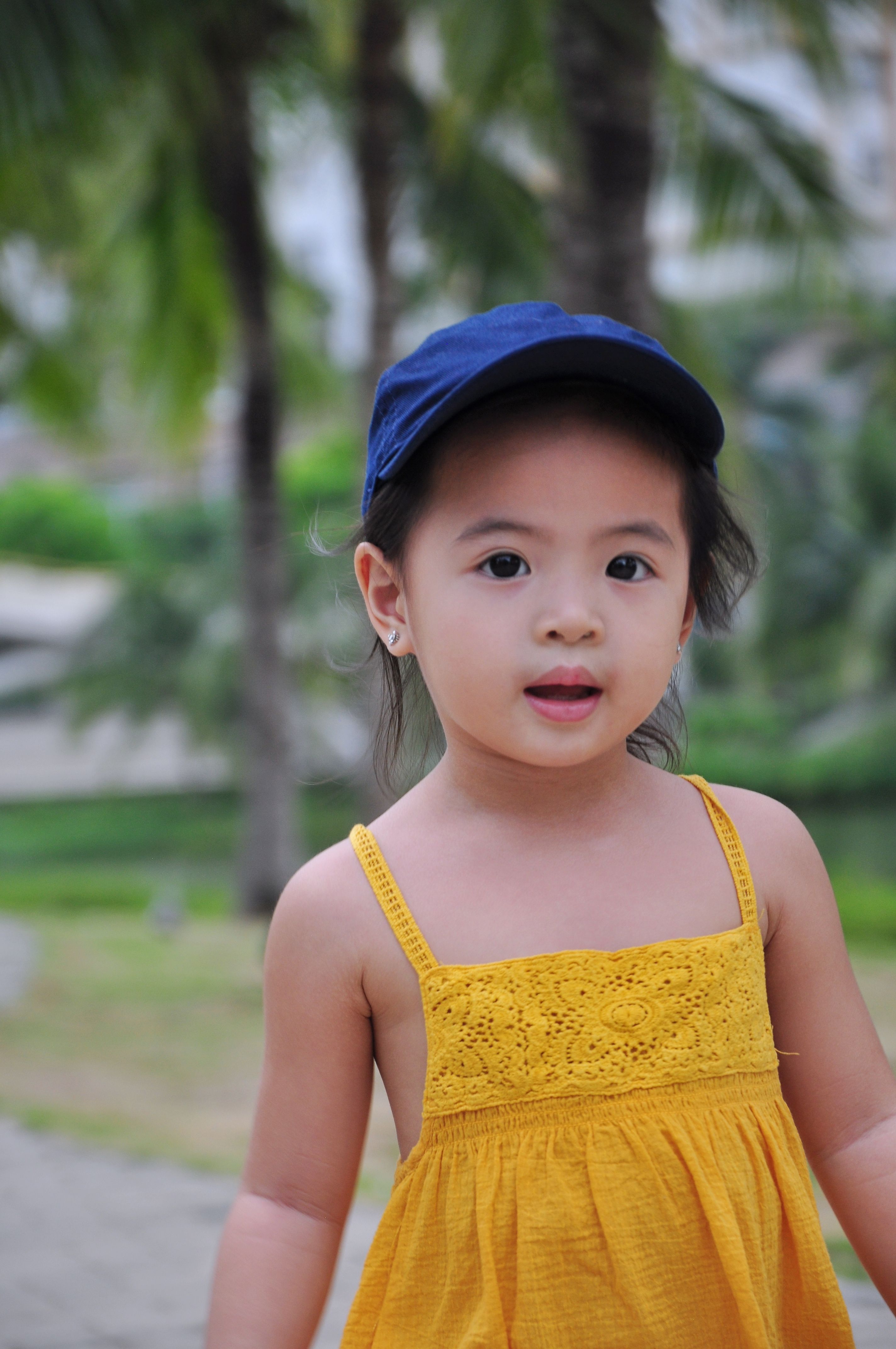 Adorable Asian Girl in Yellow Dress Outdoors · Free Stock Photo