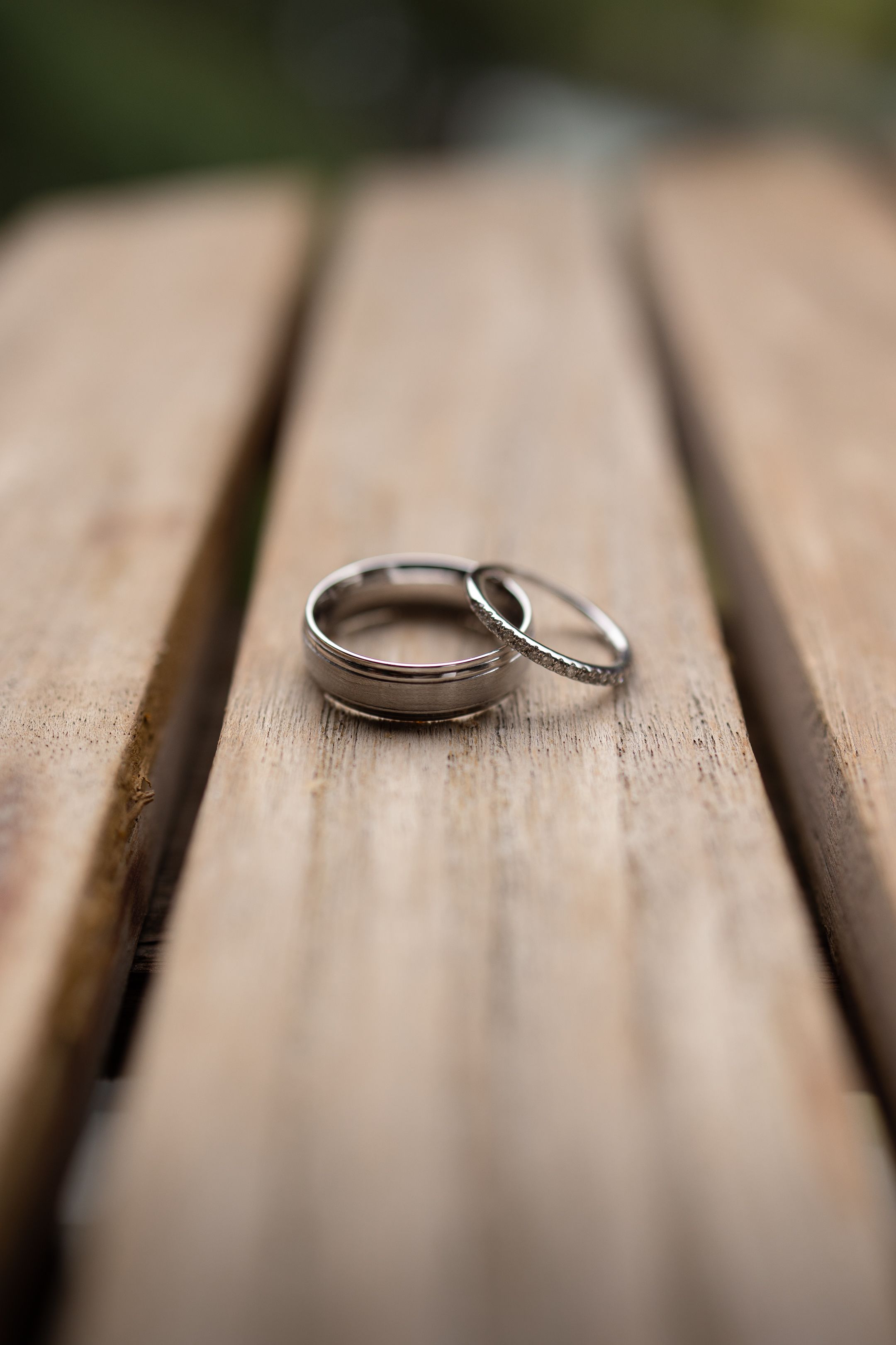 Elegant Wedding Rings on Rustic Wood Surface · Free Stock Photo