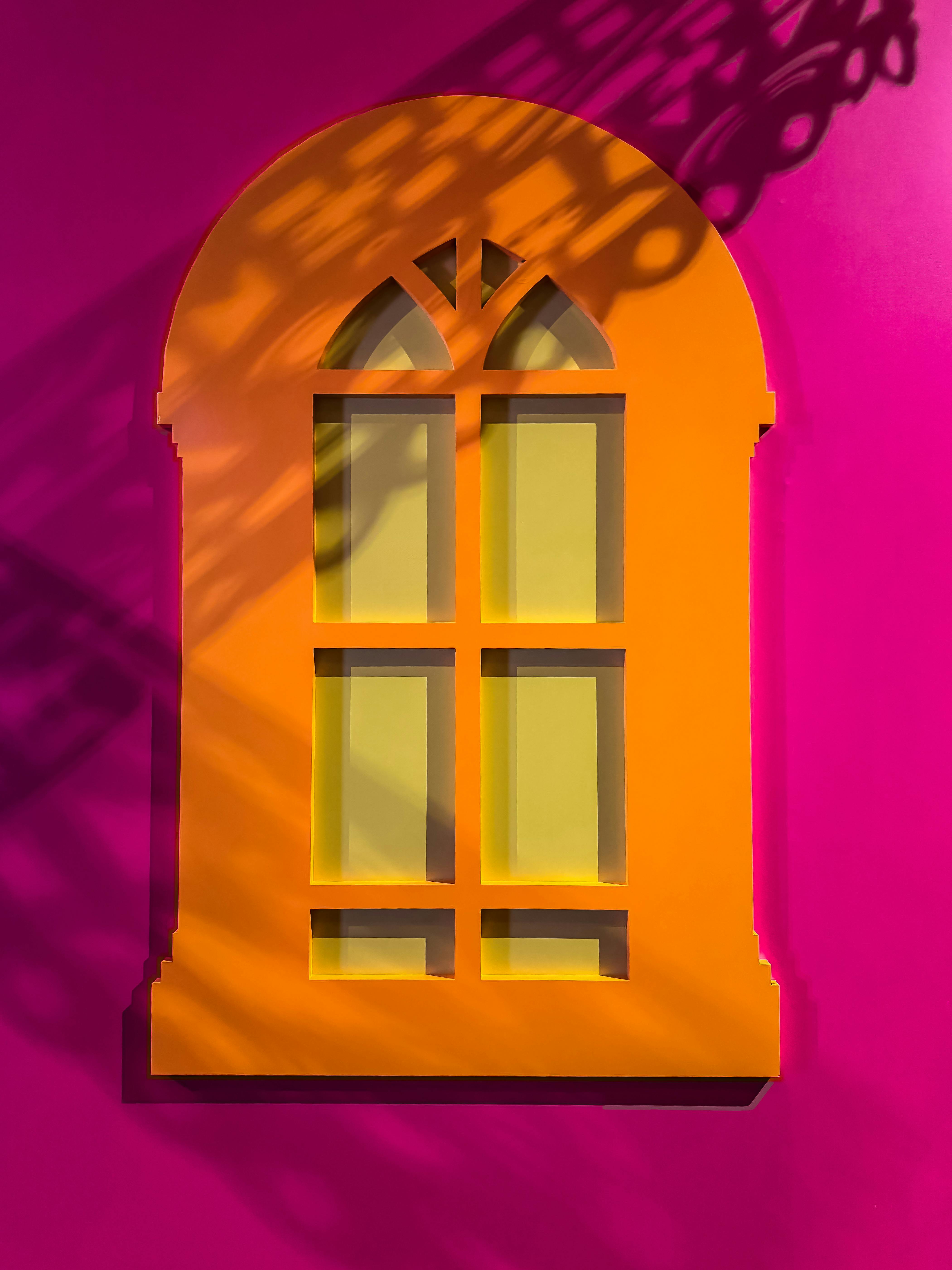 Colorful Arched Window on Vibrant Wall · Free Stock Photo