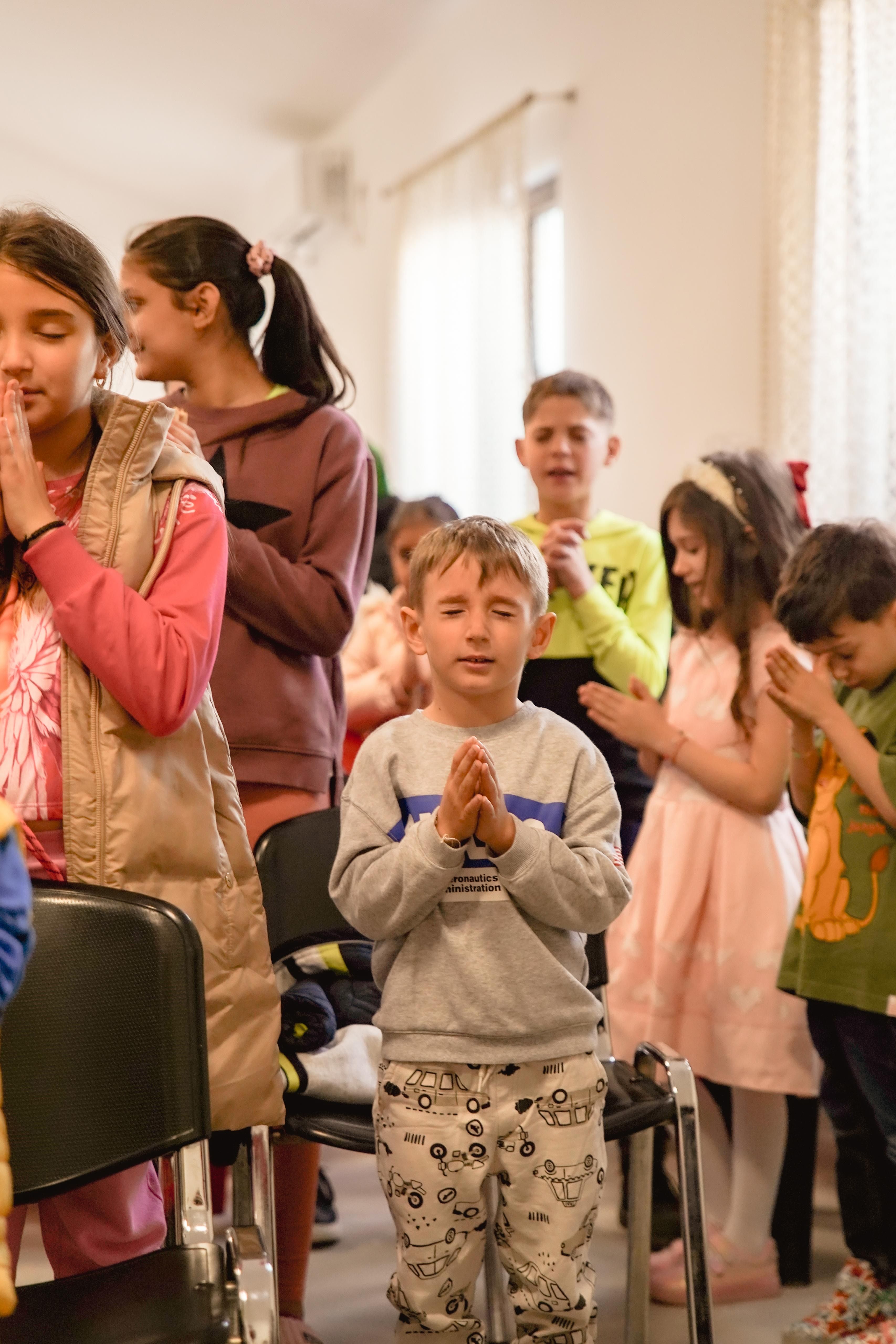 Group of Children in Prayer at Indoor Event · Free Stock Photo