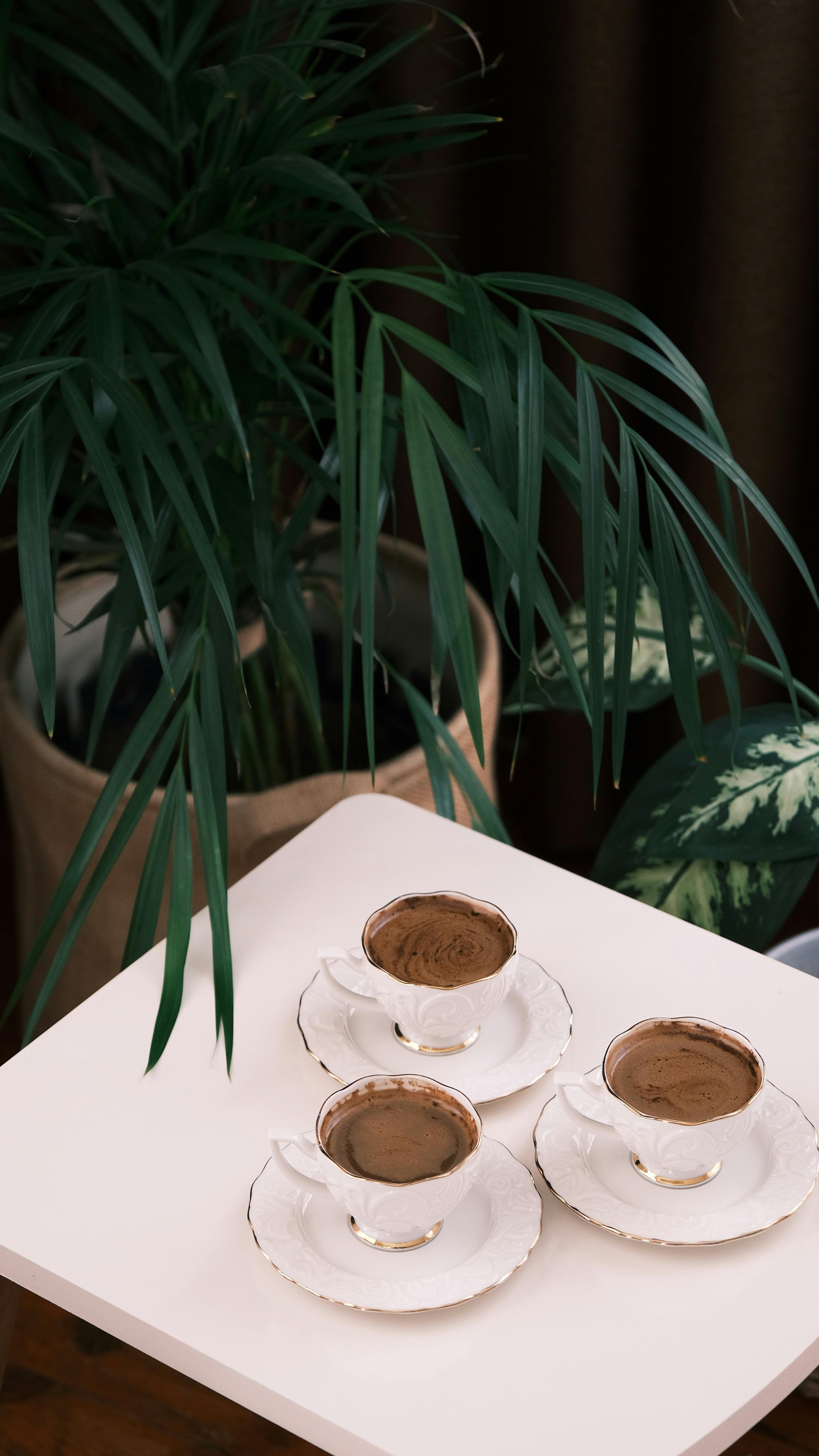 Three Elegant Coffee Cups on White Table · Free Stock Photo