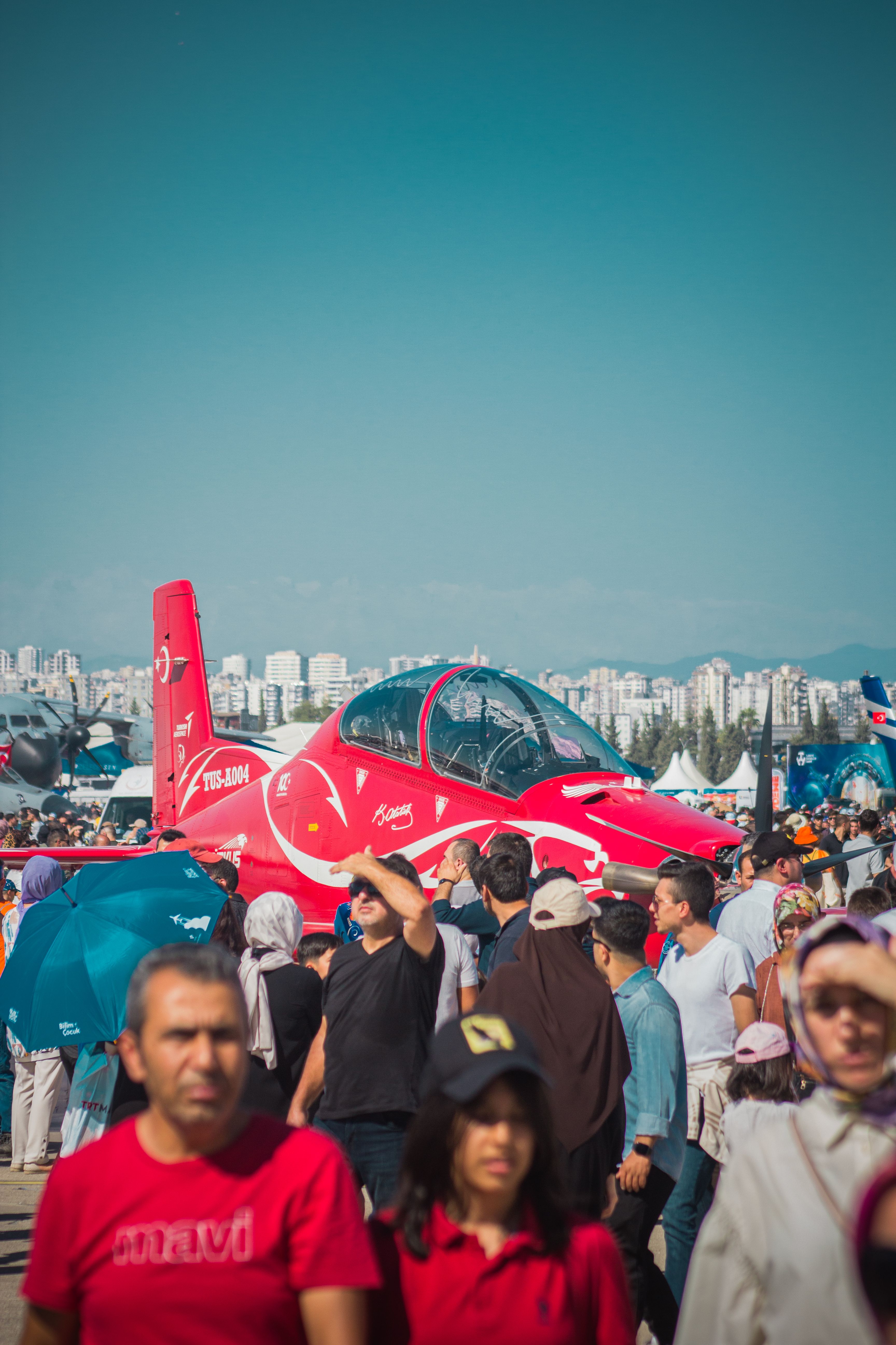 Vibrant Airshow with Red Jet and Crowd · Free Stock Photo