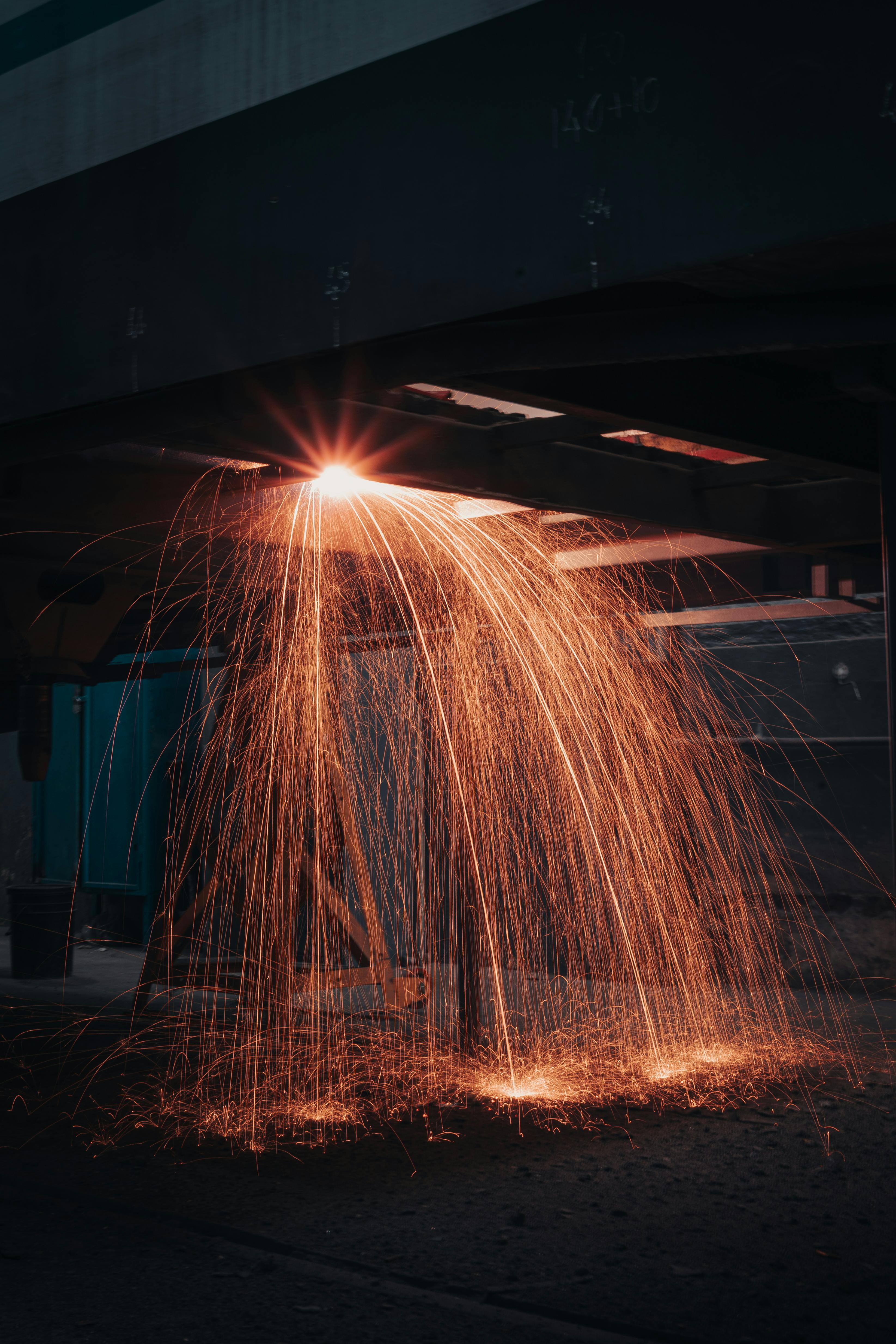 Dramatic Steel Sparks in Industrial Setting · Free Stock Photo