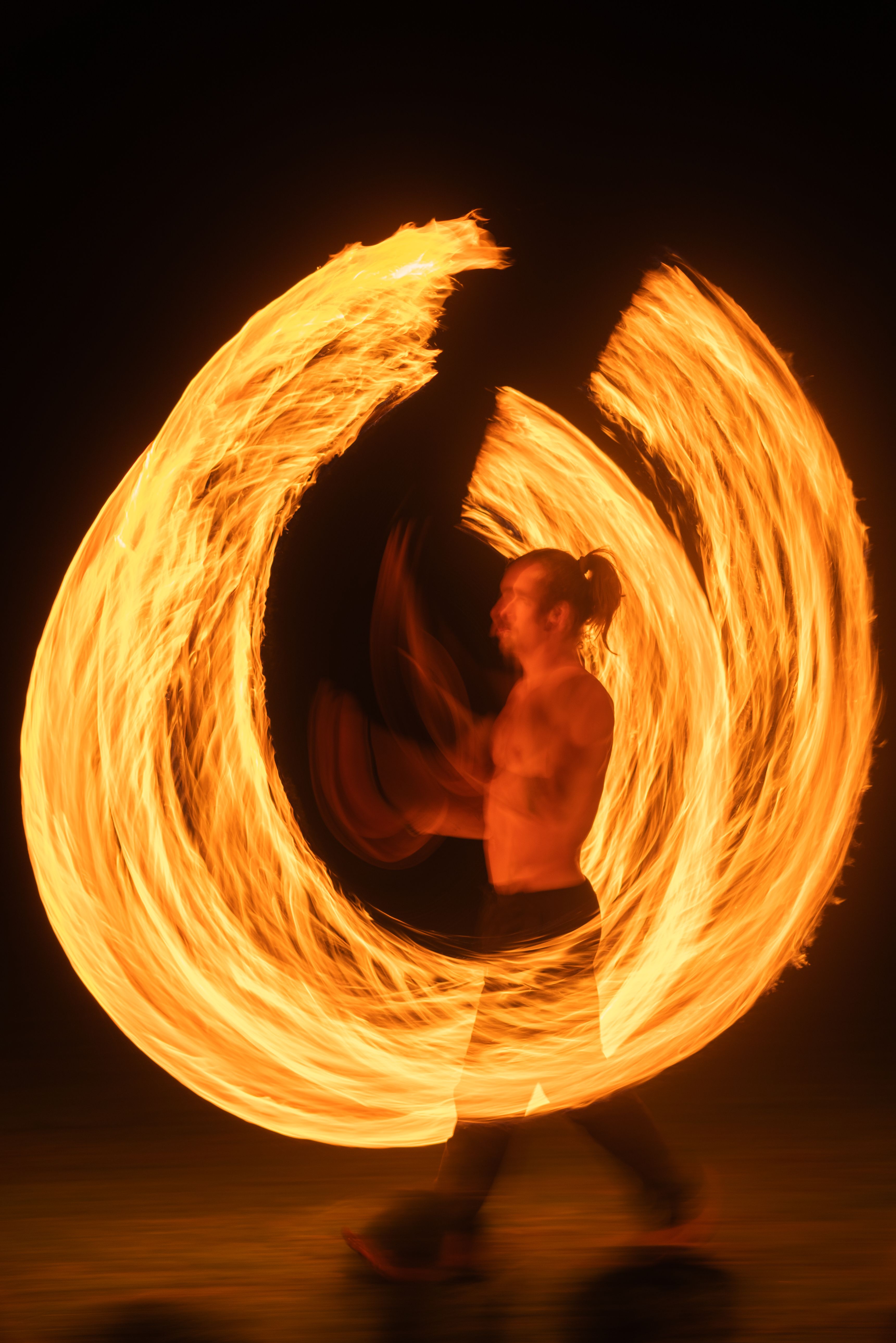 Dynamic Fire Performer in Motion at Night · Free Stock Photo