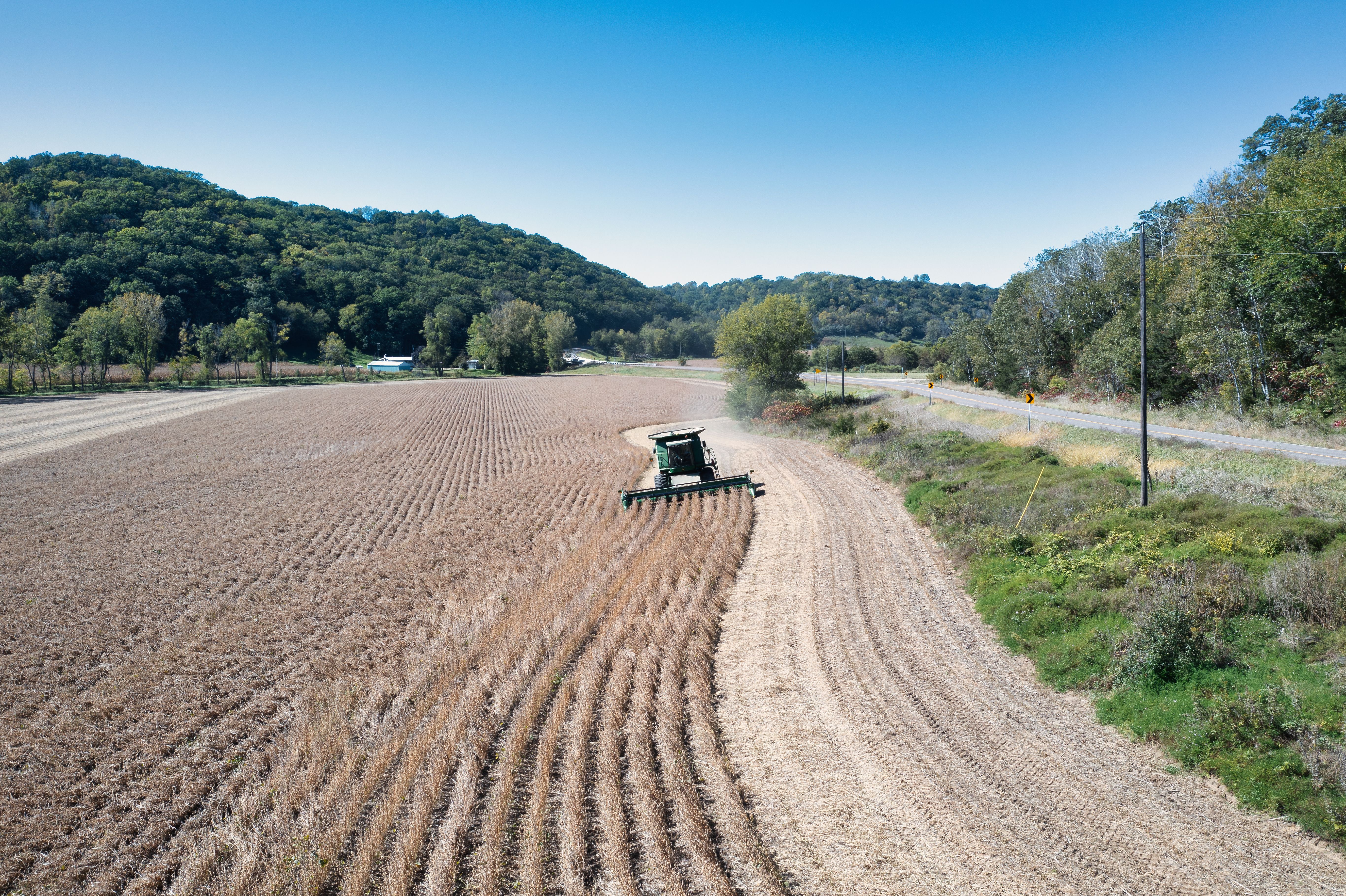 Combine Harvester in Rural Fall Landscape · Free Stock Photo