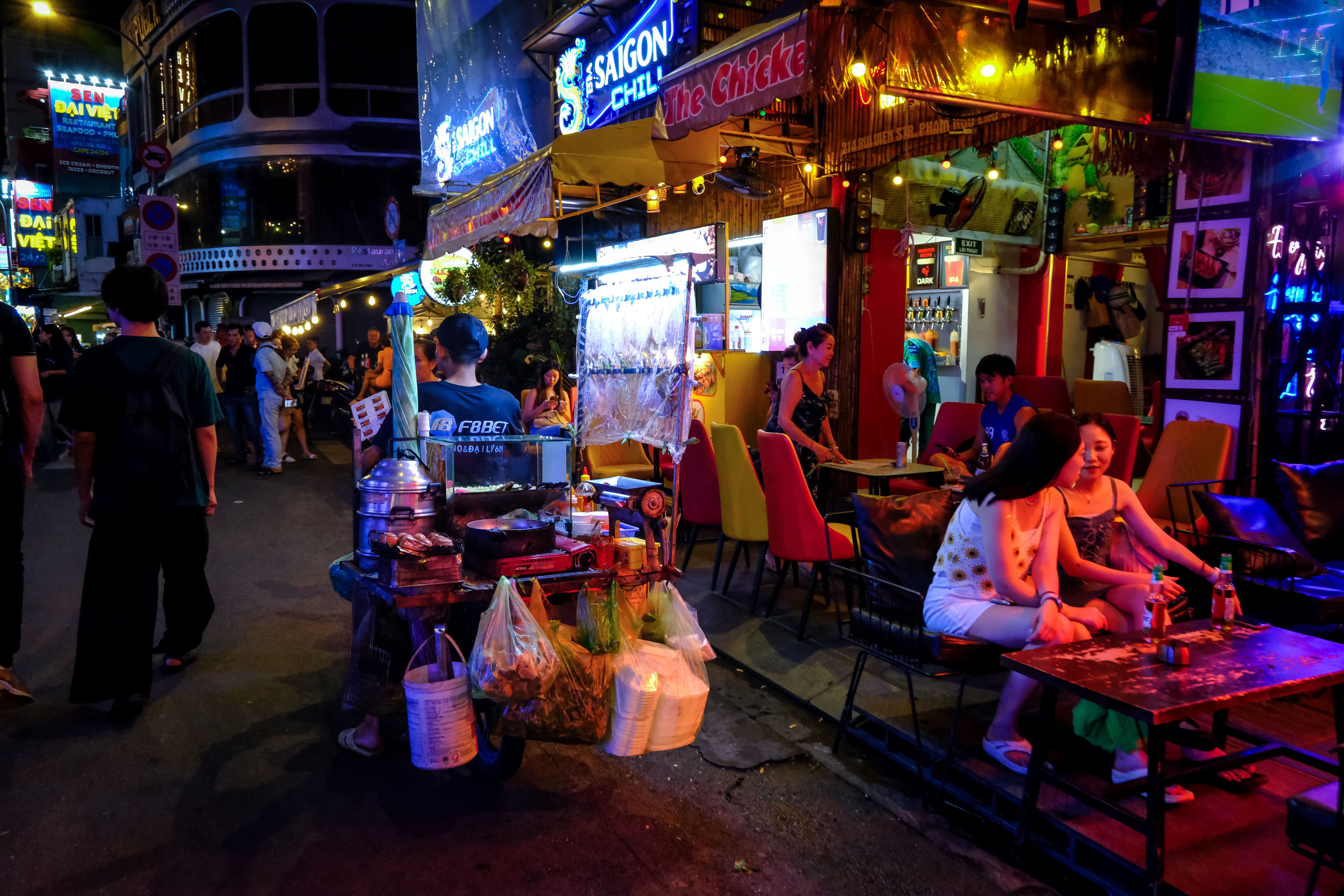 Vibrant Saigon Street Food Scene at Night · Free Stock Photo