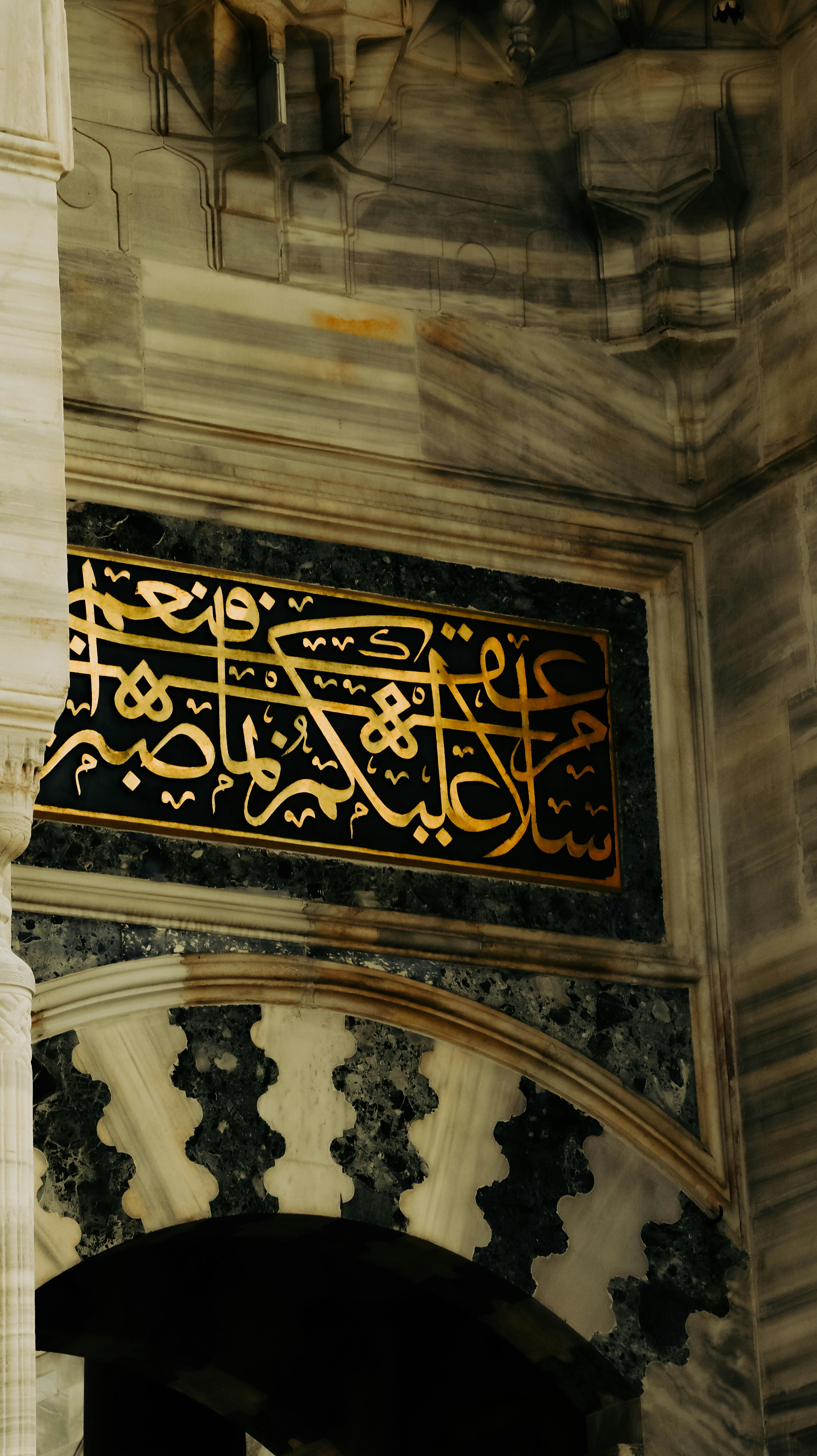 Intricate Arabic Calligraphy on Stone Archway · Free Stock Photo