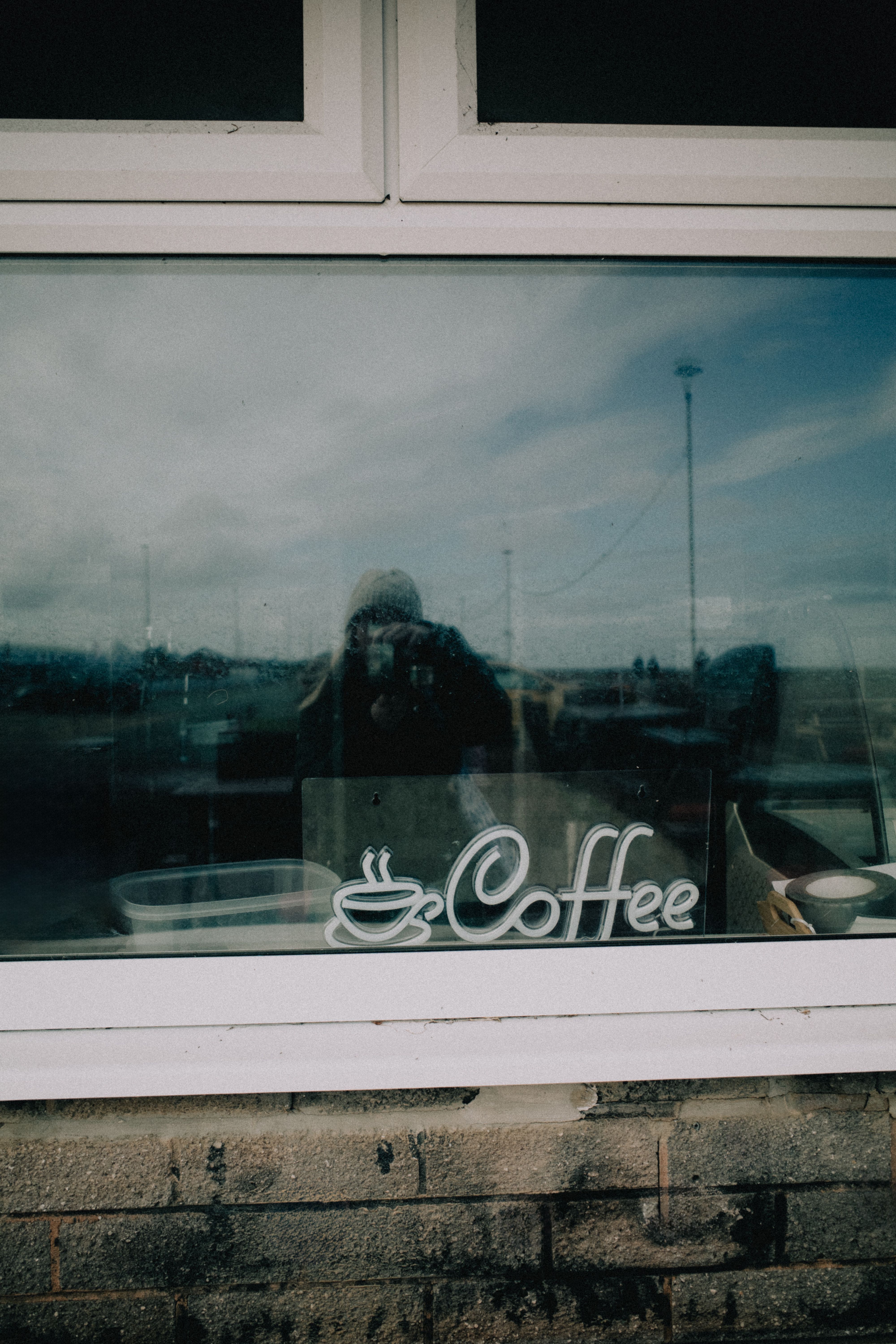 Reflection in Cafe Window with Coffee Sign · Free Stock Photo