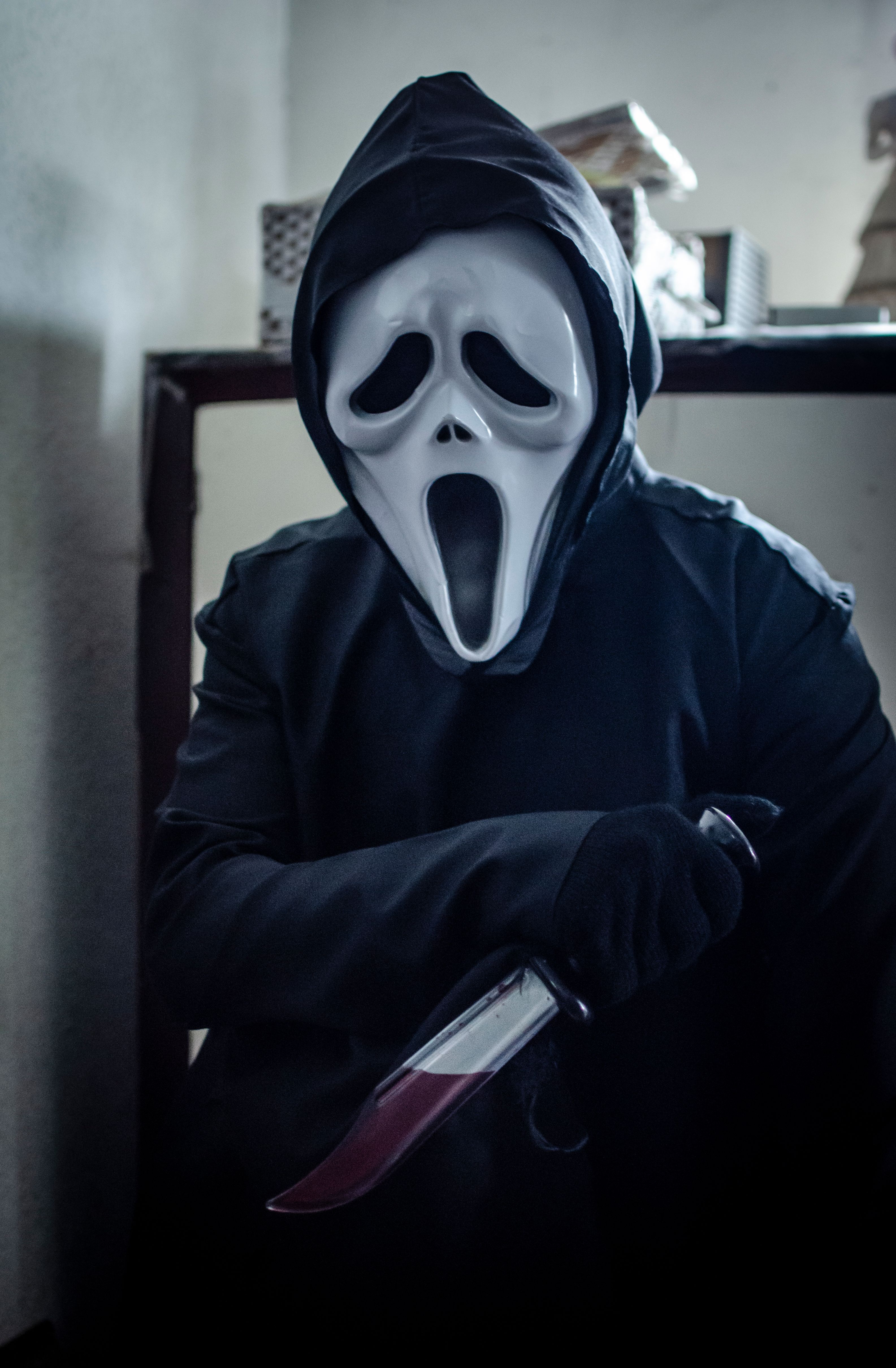 Spooky Masked Figure with Knife in Dark Room · Free Stock Photo