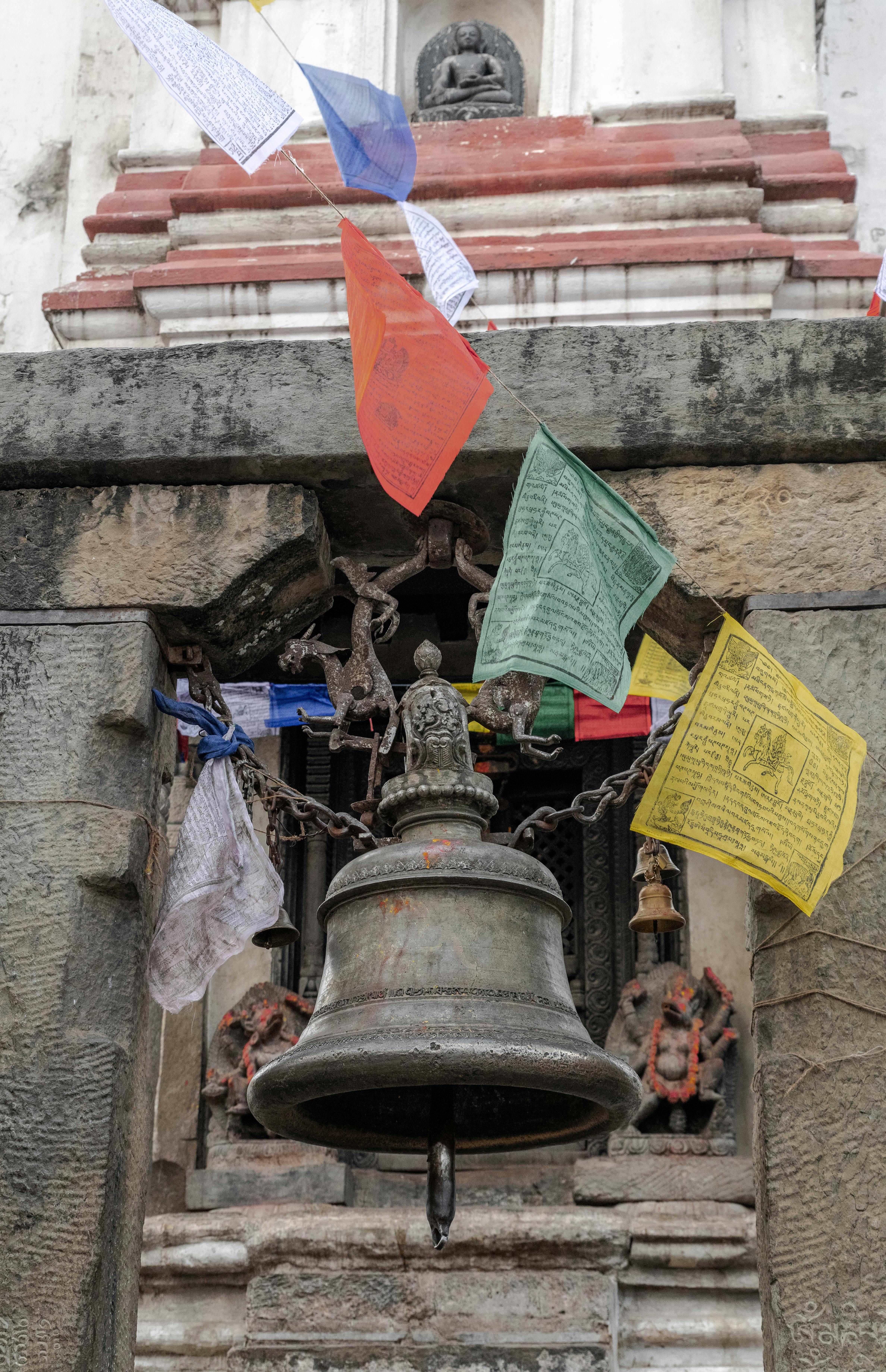 Ancient Temple Bell with Colorful Prayer Flags · Free Stock Photo