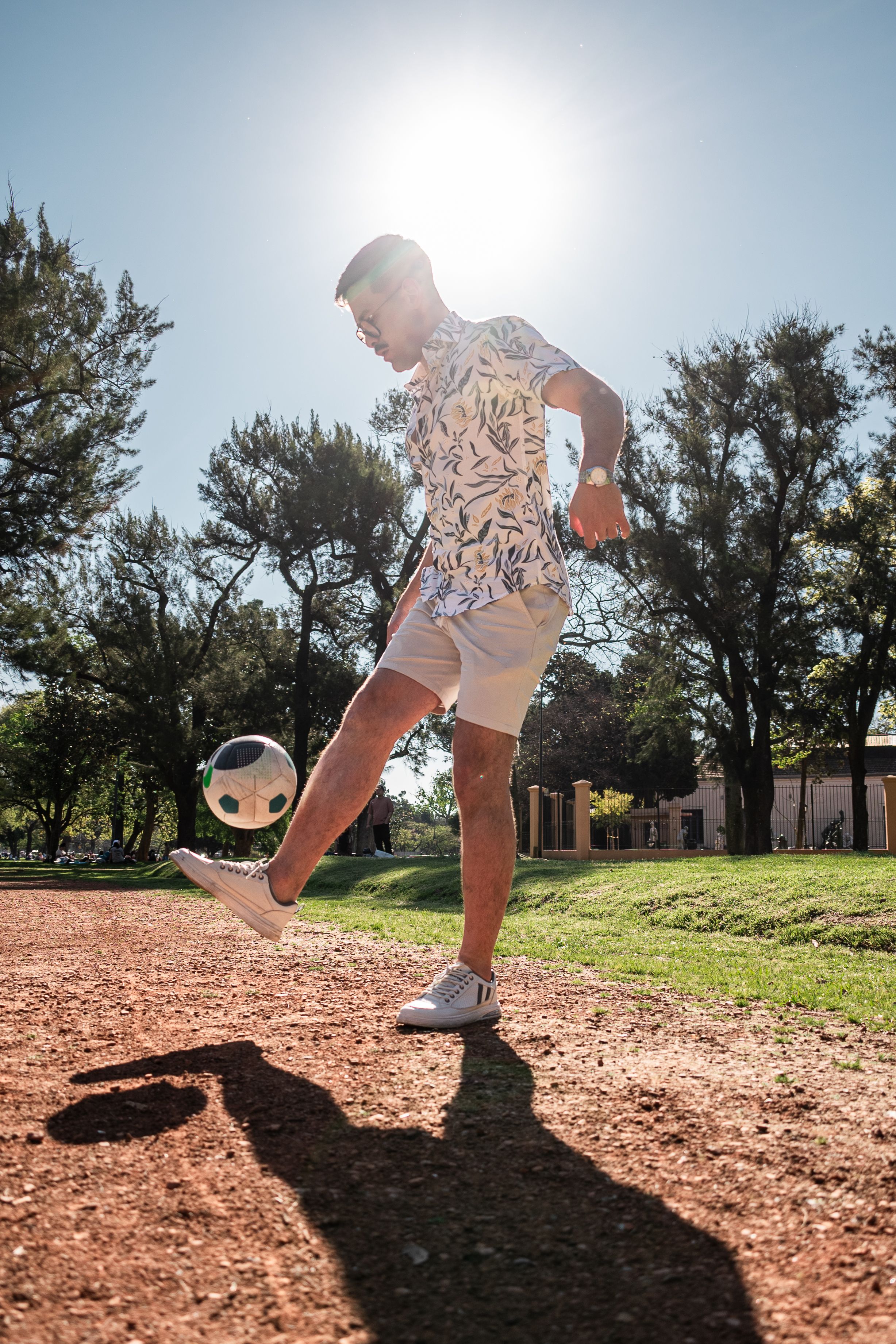 Man Enjoying Soccer in a Sunny Park · Free Stock Photo