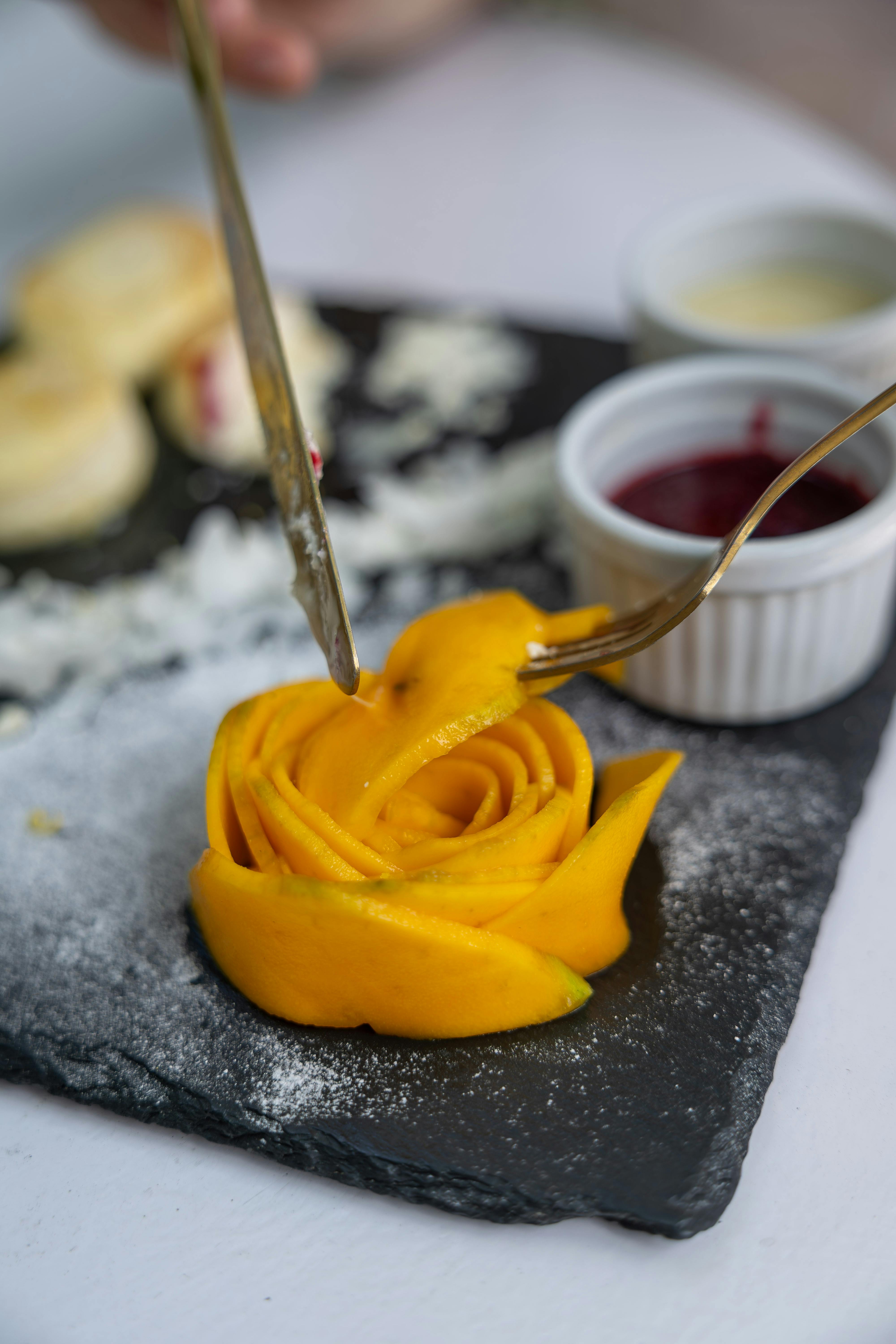 Elegant Mango Rose Dessert in a Café Setting · Free Stock Photo