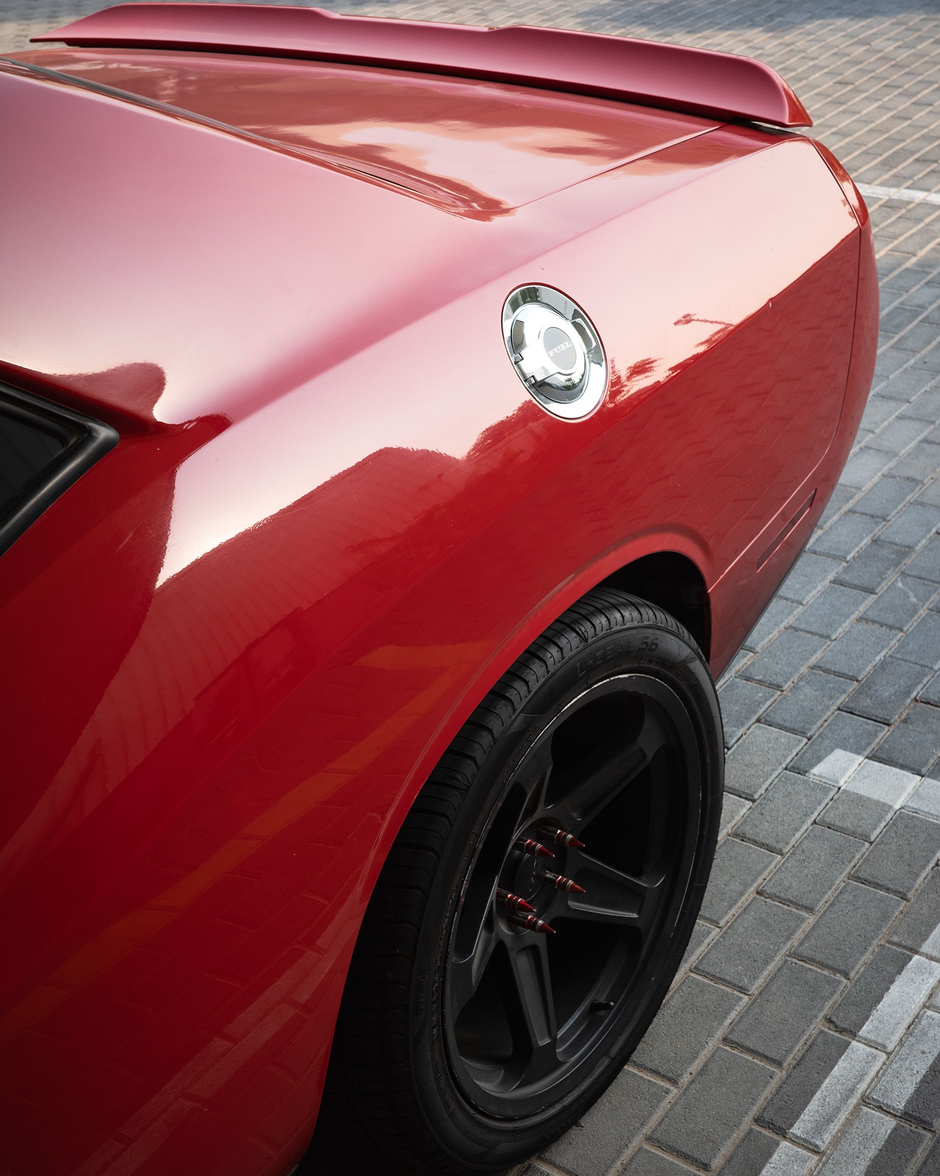 Close-Up of Red Classic Car on Brick Pavement · Free Stock Photo