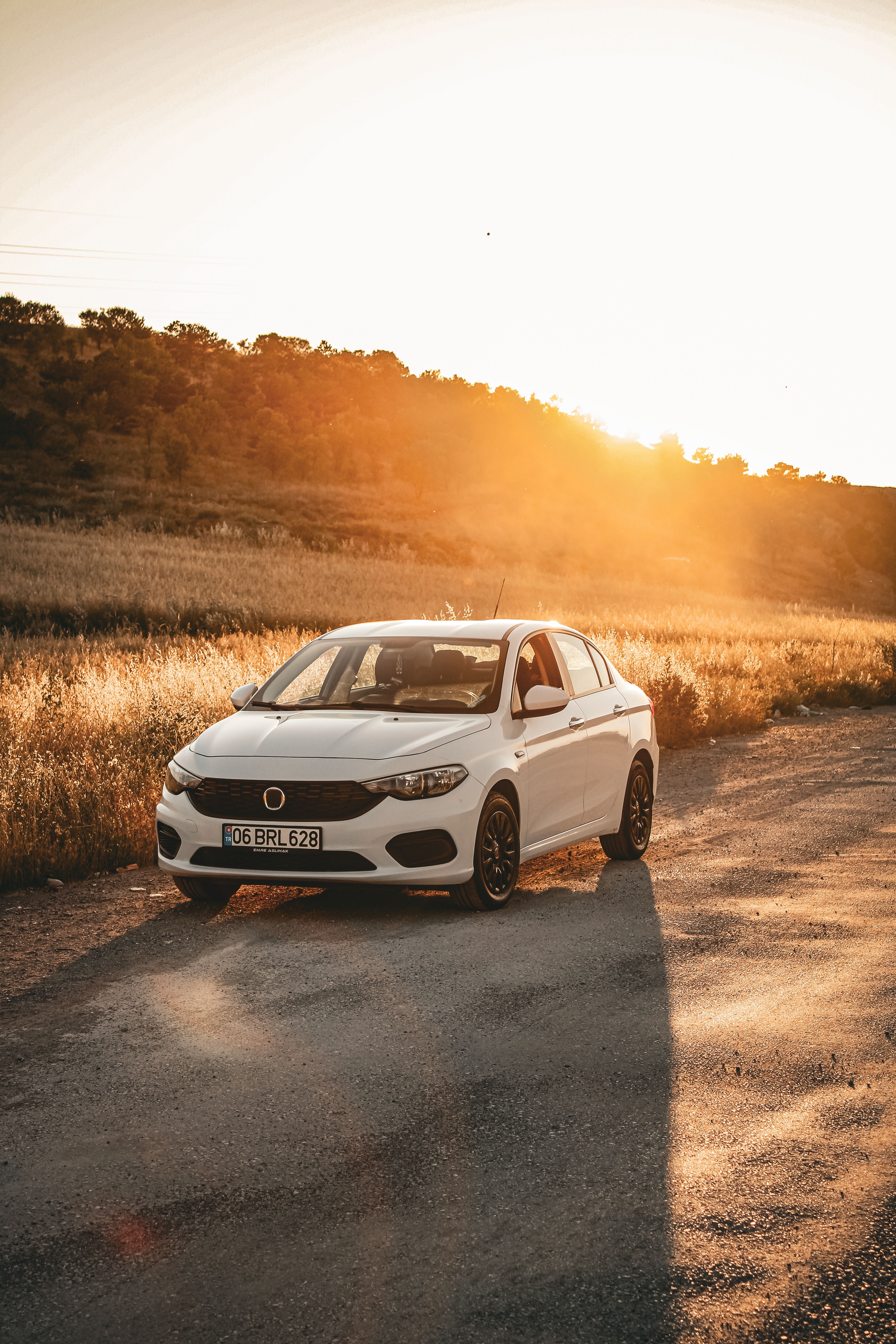 White Sedan Car on Rural Road at Sunset · Free Stock Photo
