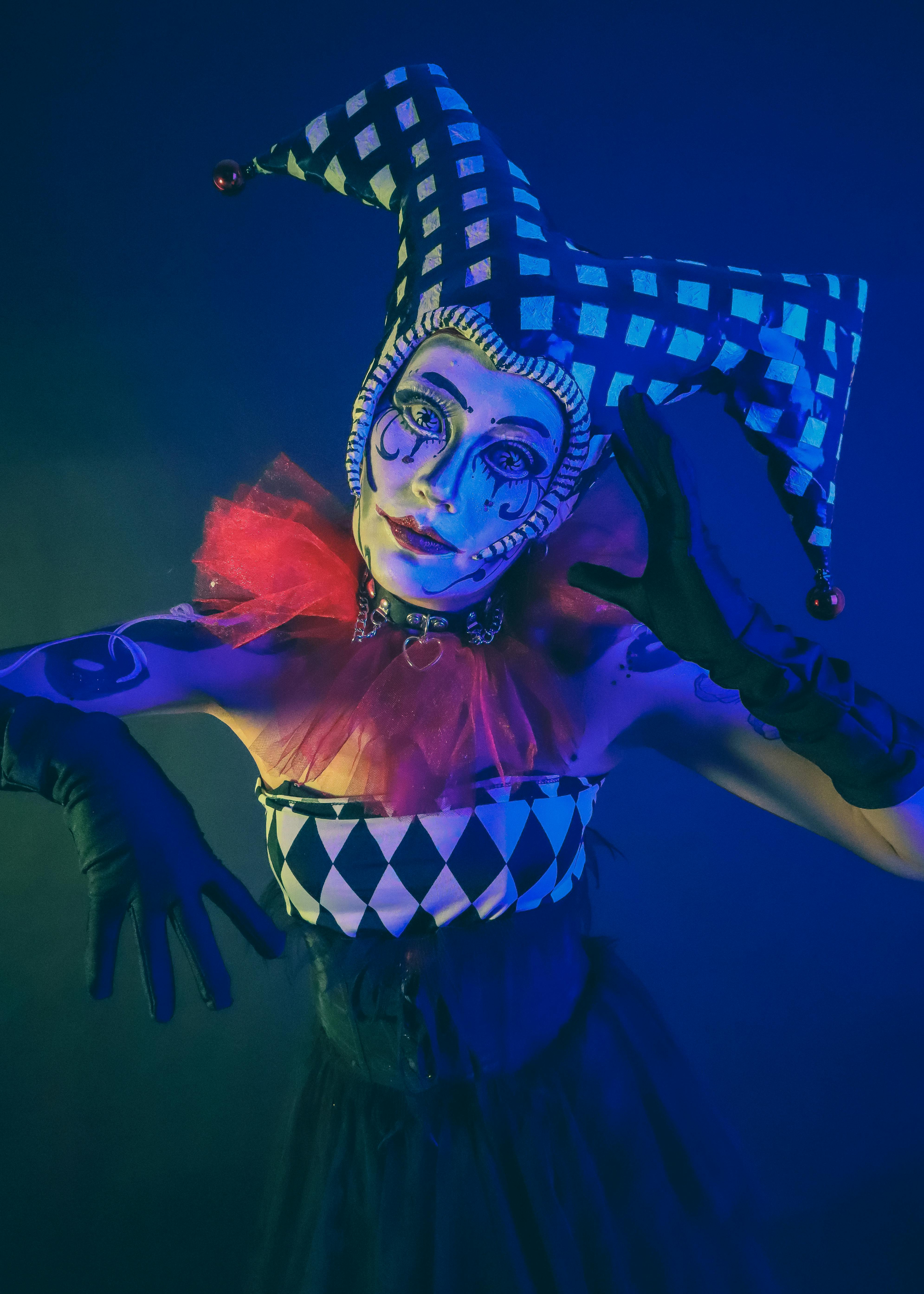 Colorful Jester in a Checkerboard Costume · Free Stock Photo
