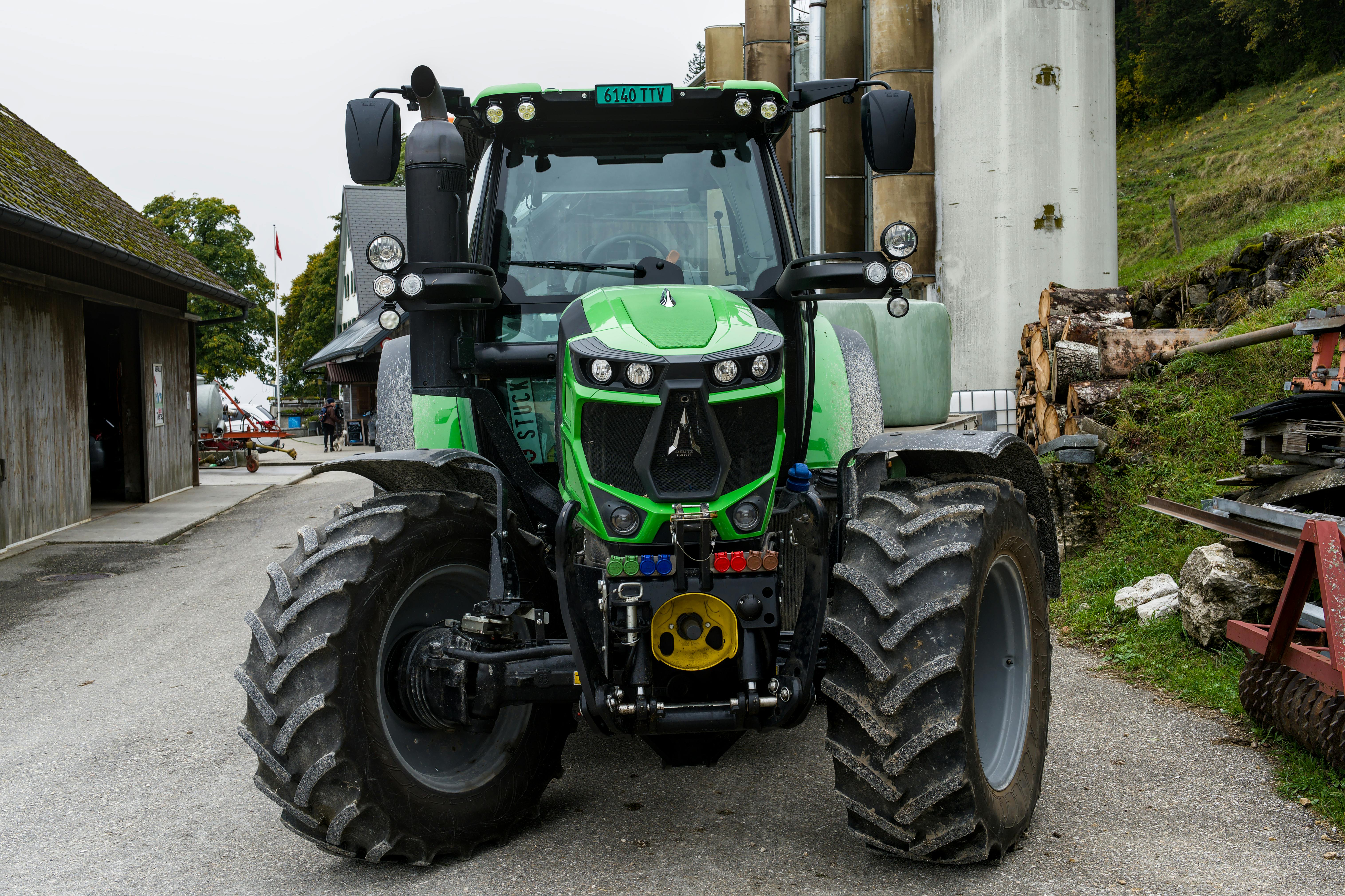 Front View of Green Tractor on Rural Farm · Free Stock Photo