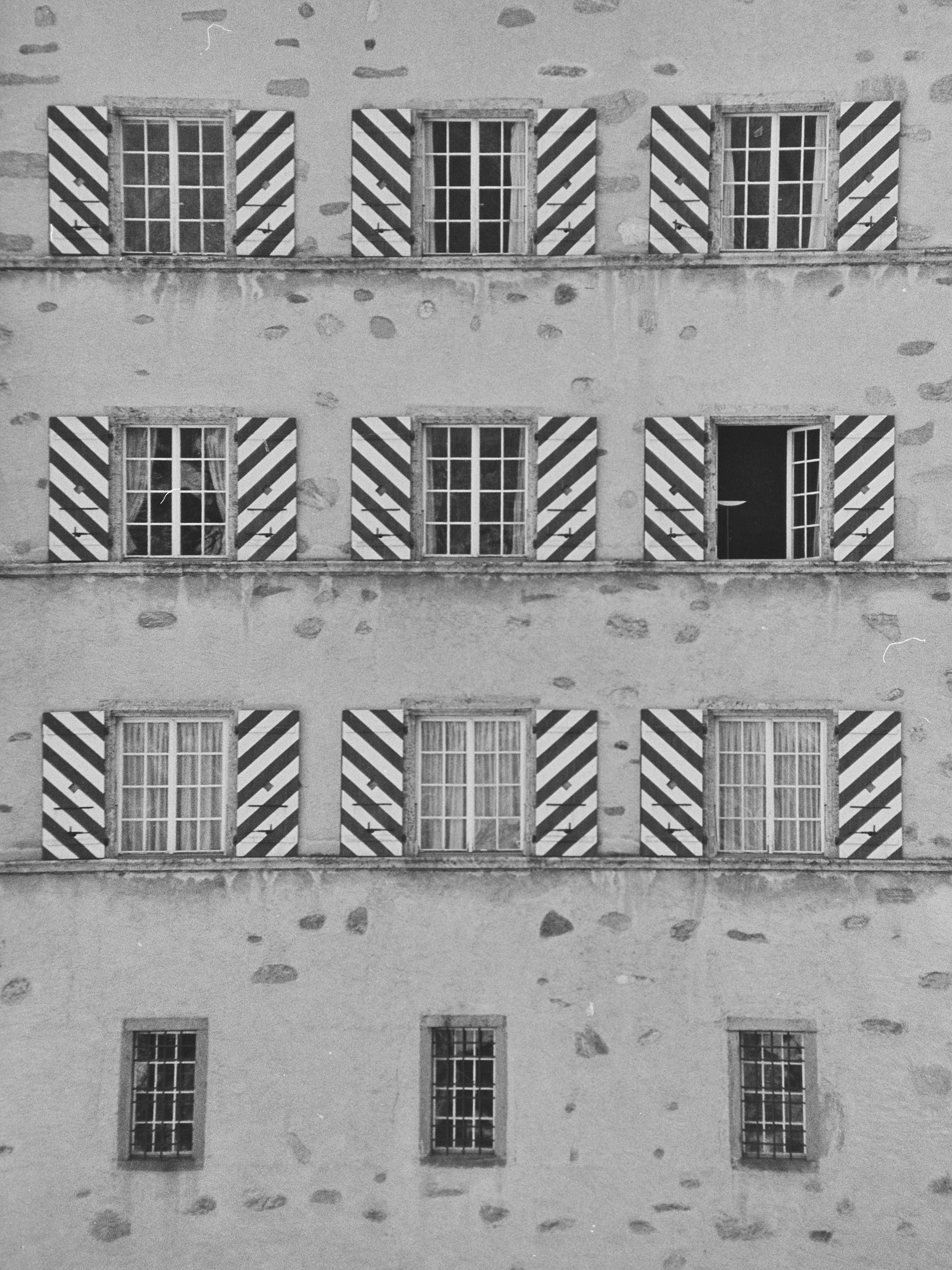 Historic Building Facade with Striped Shutters · Free Stock Photo