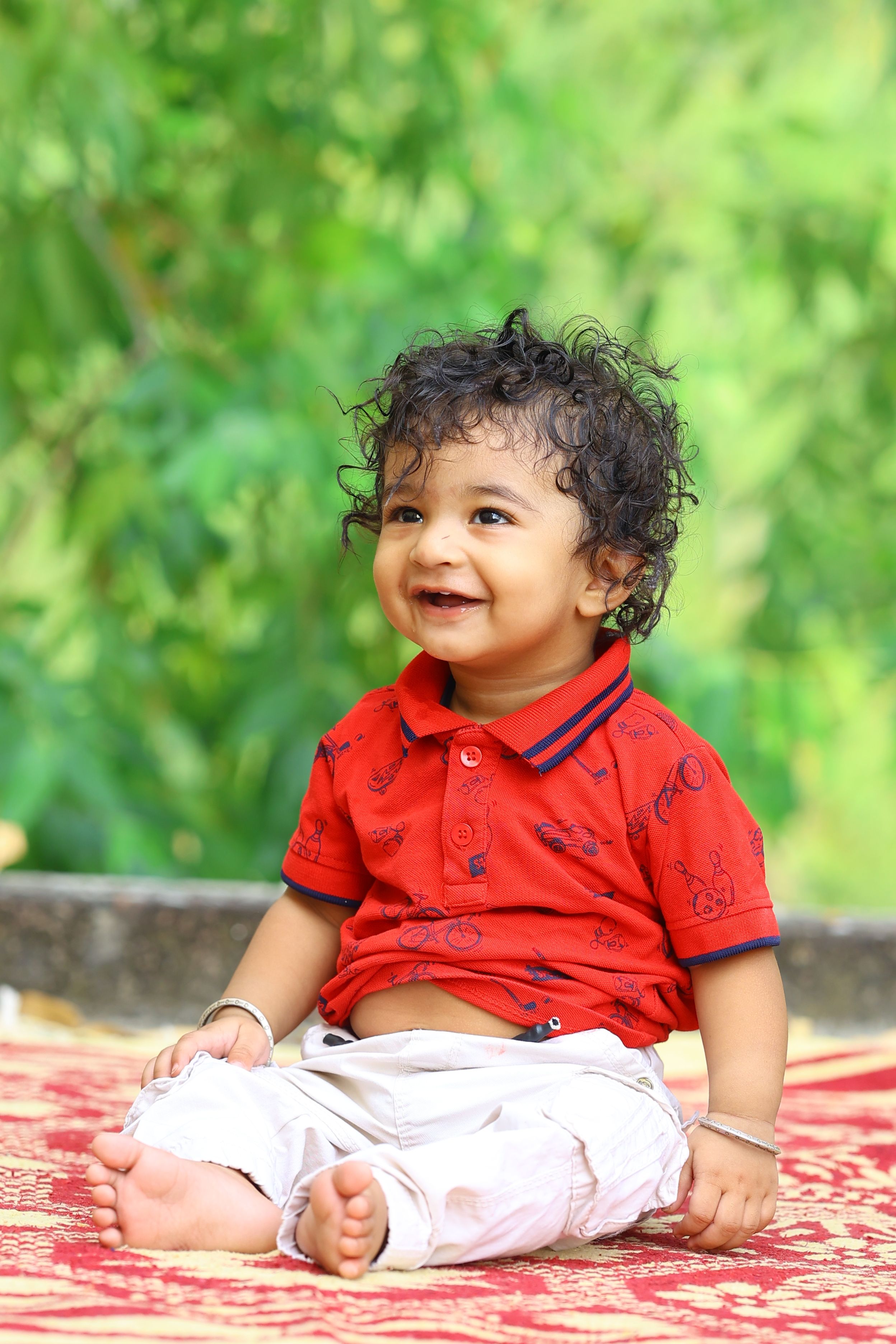 Smiling Baby in Red Shirt Outdoors · Free Stock Photo