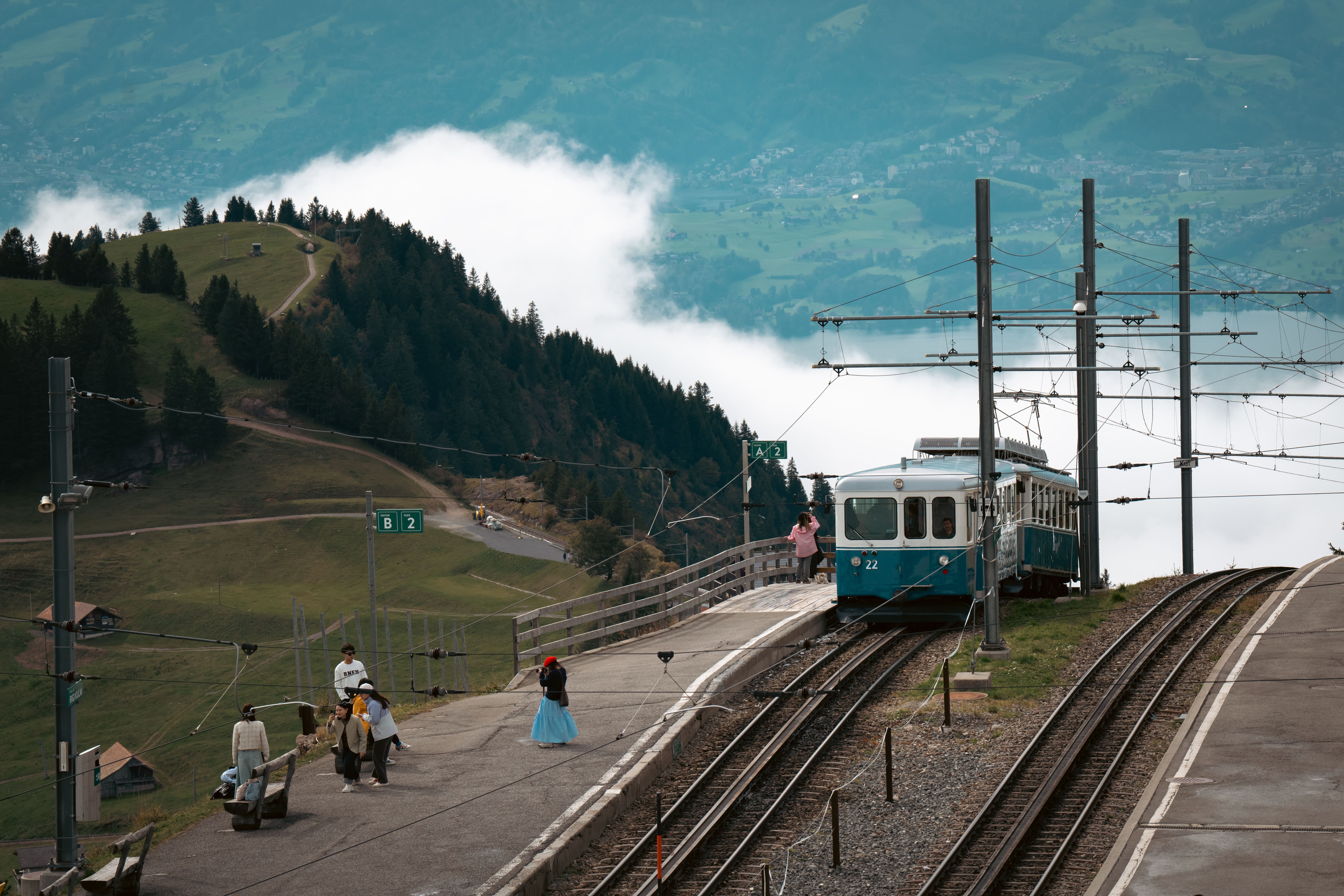 Scenic Mountain Train Station with Blue Train · Free Stock Photo