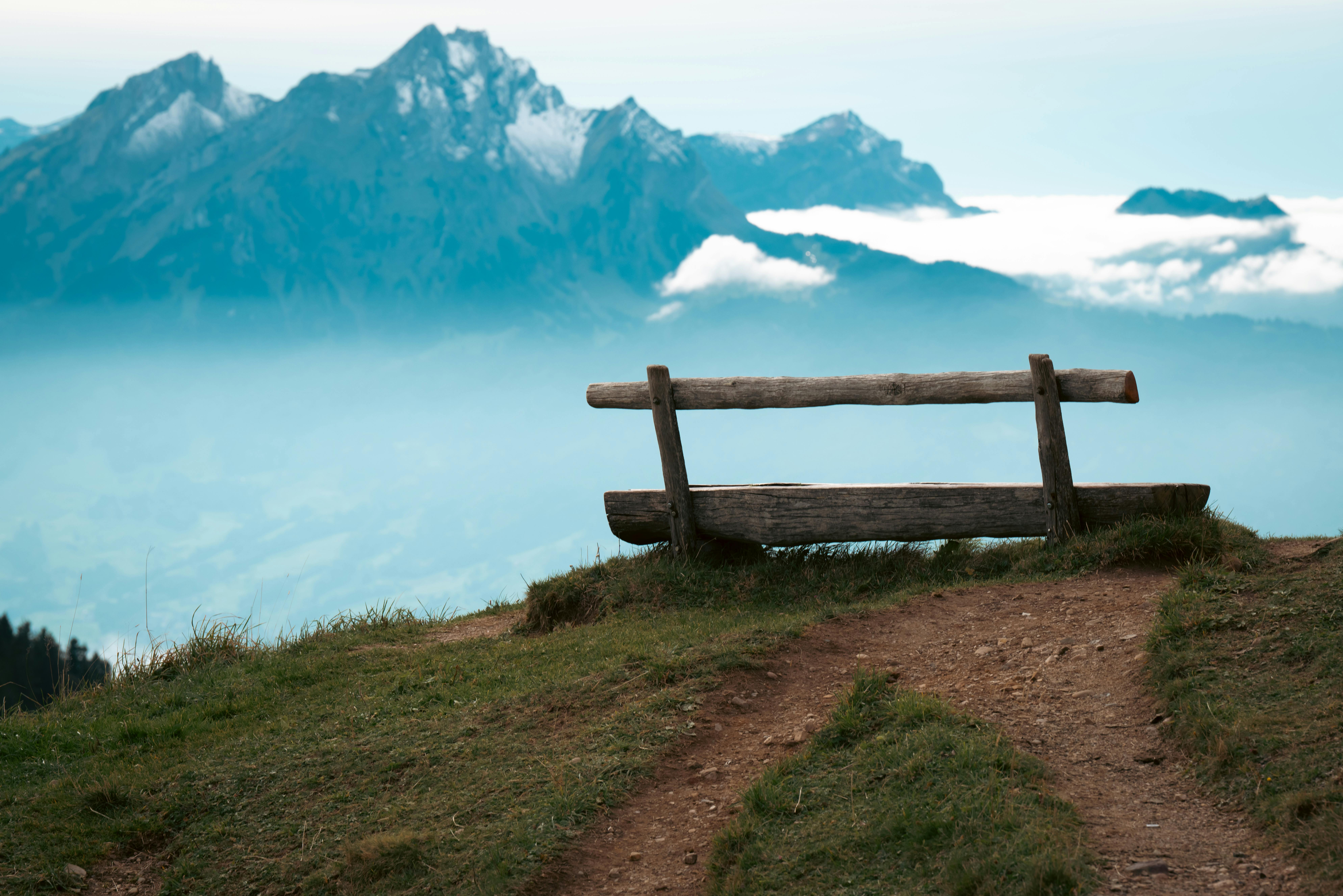 Rustic Bench Overlooking Majestic Mountain Landscape · Free Stock Photo
