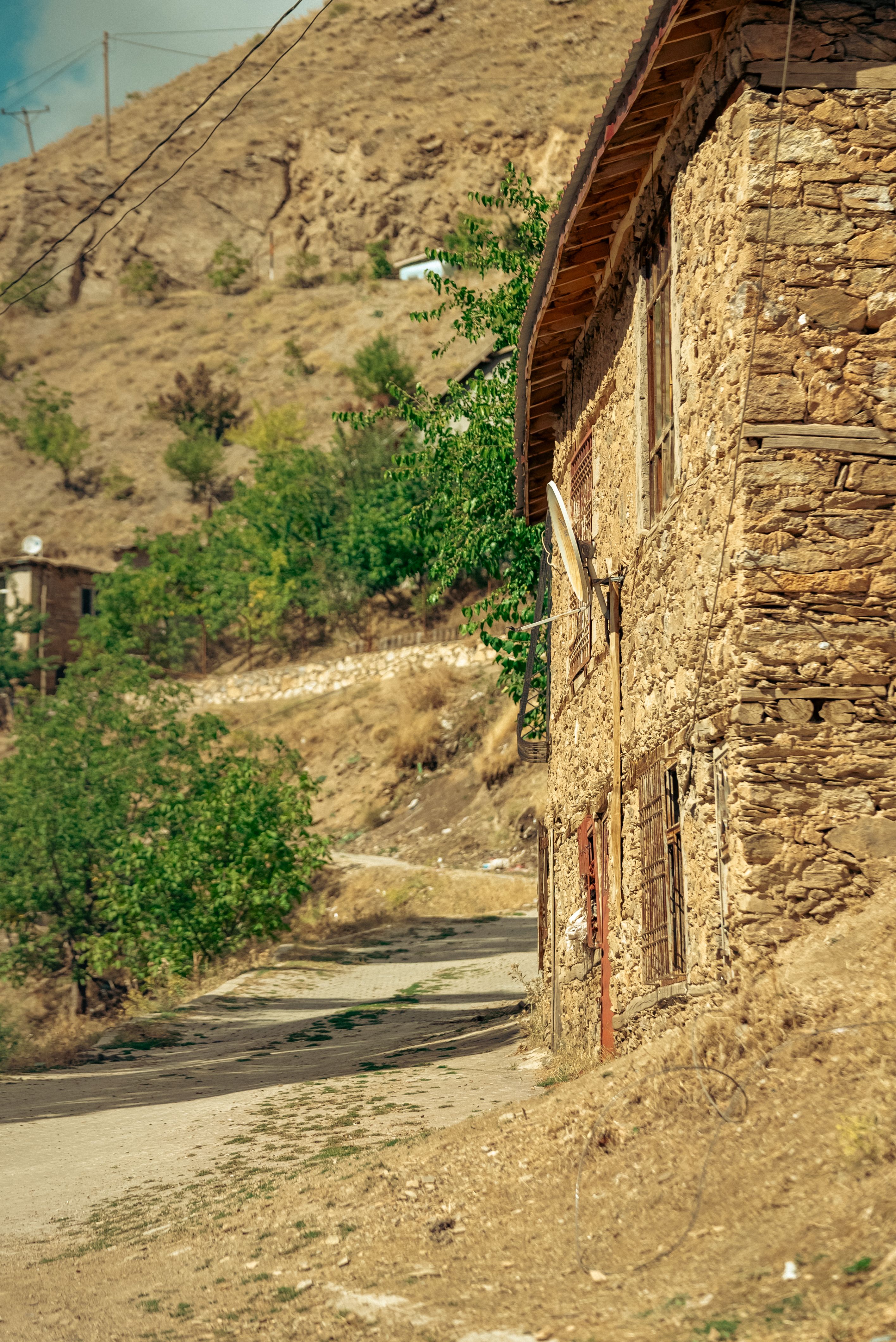 Rustic Stone House in Serene Village Setting · Free Stock Photo