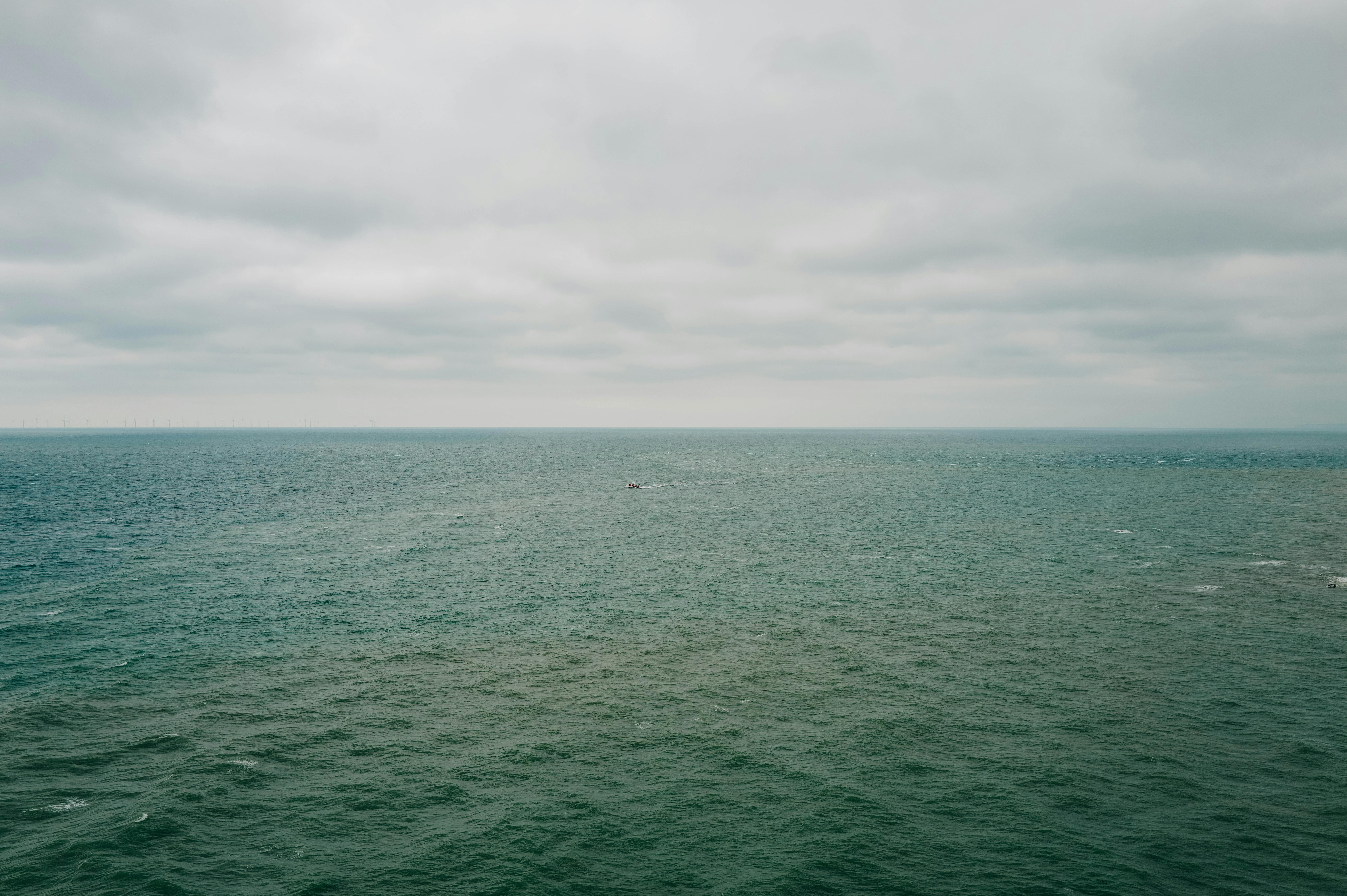 Calm Ocean View Under Cloudy Skies · Free Stock Photo