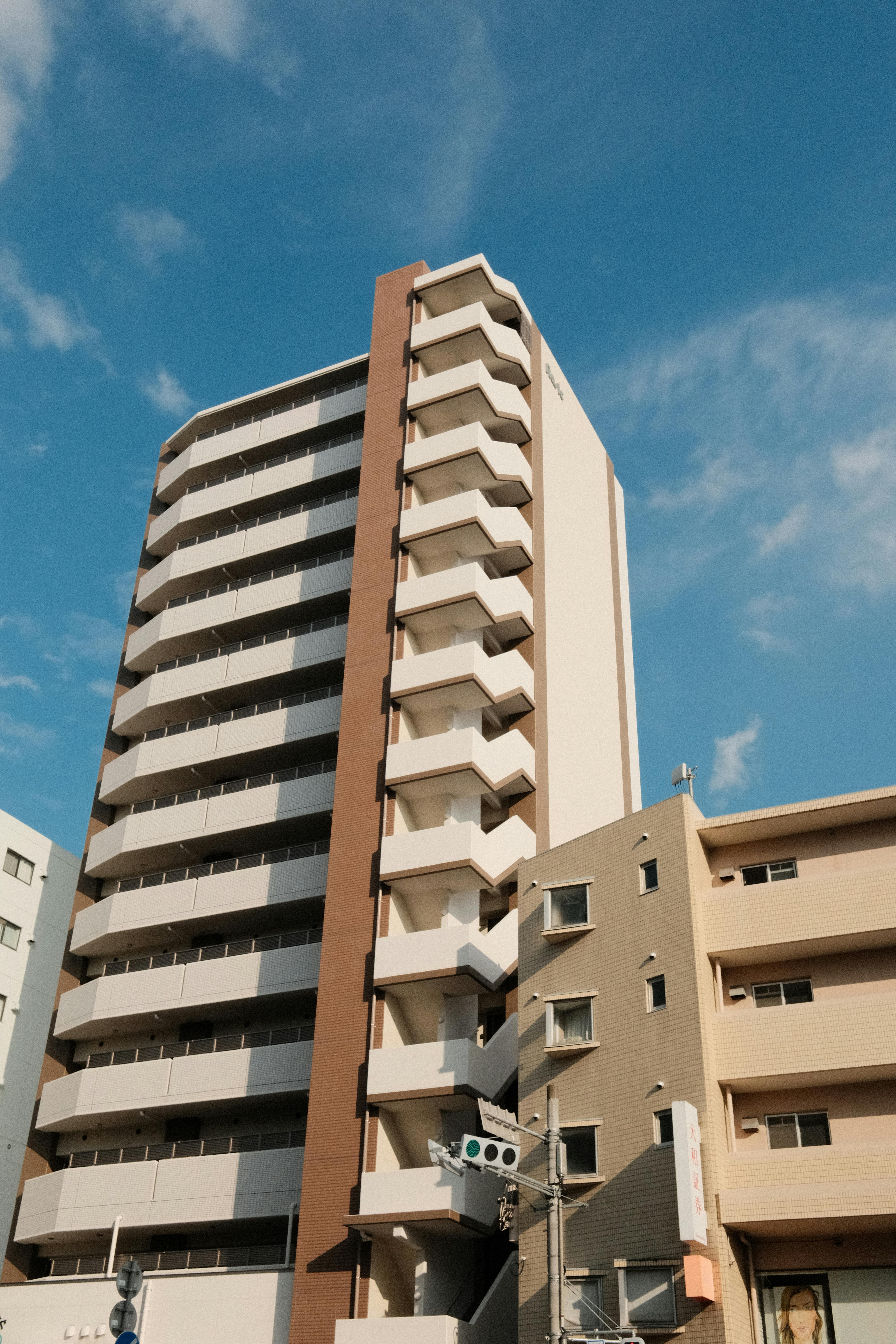 Modern Urban High-Rise Building Against Blue Sky · Free Stock Photo
